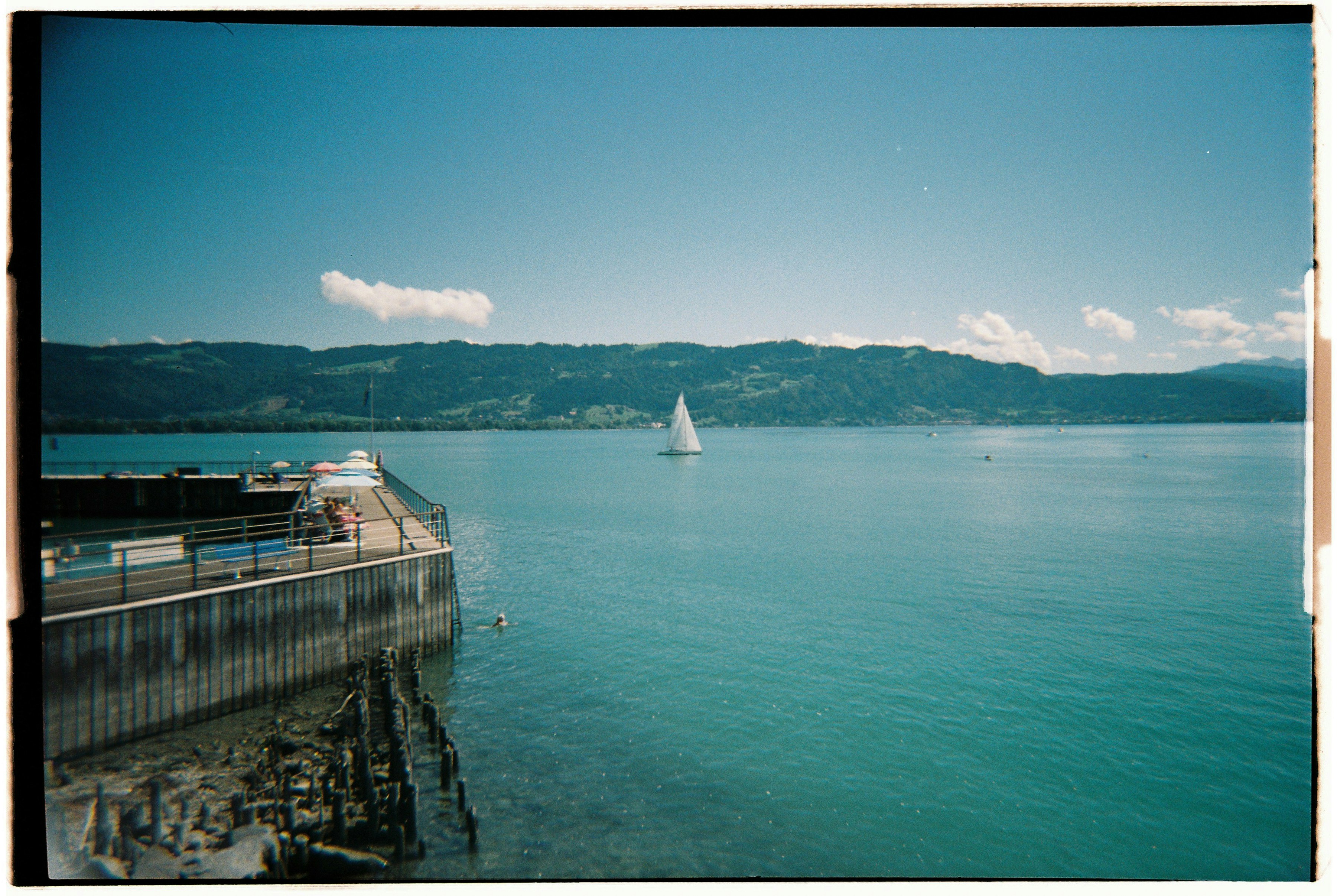 Lakeside Pier and Sail in Quiet Blue