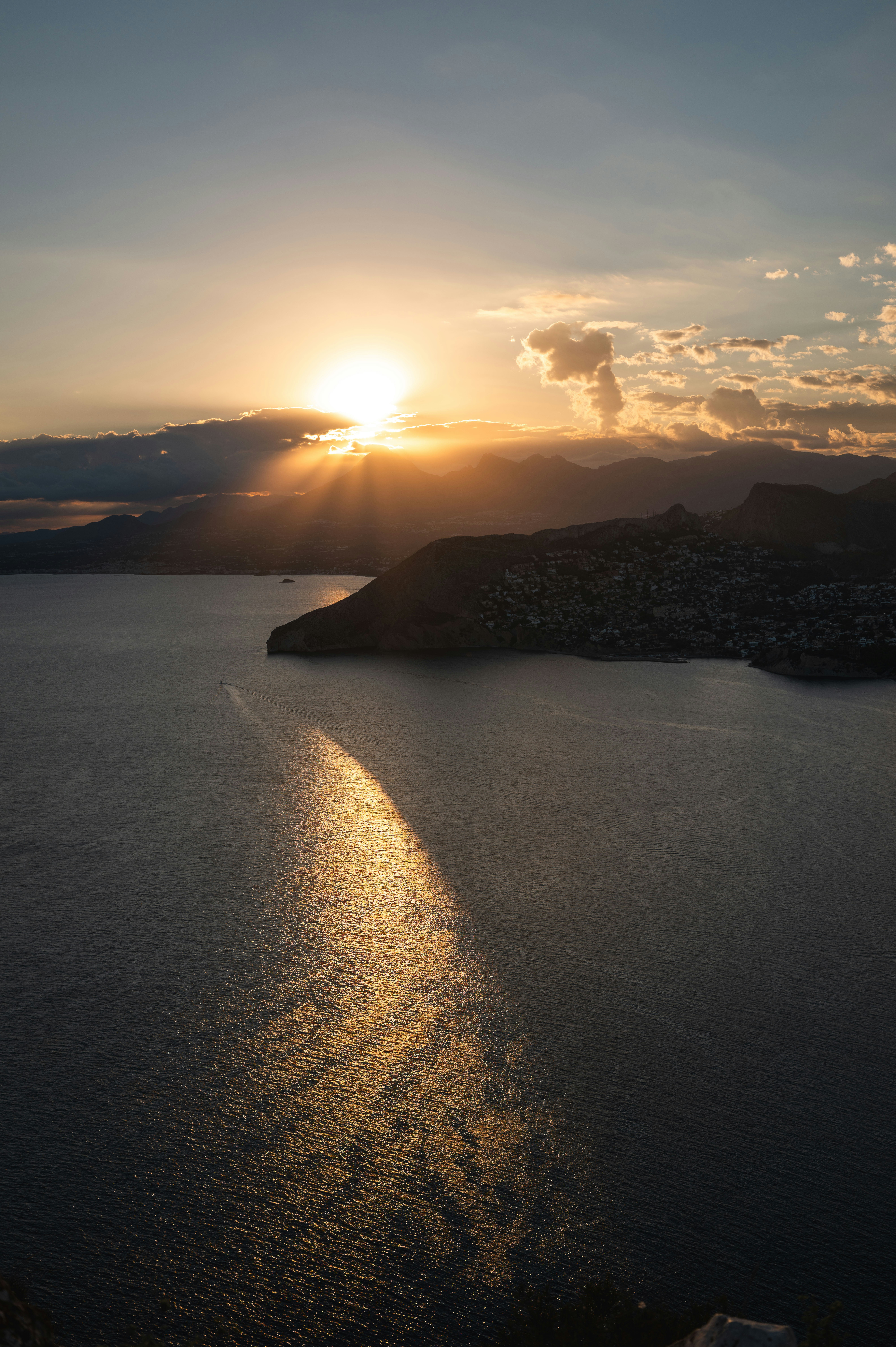 Sunlit Ridge Over Calm Waters at Dusk