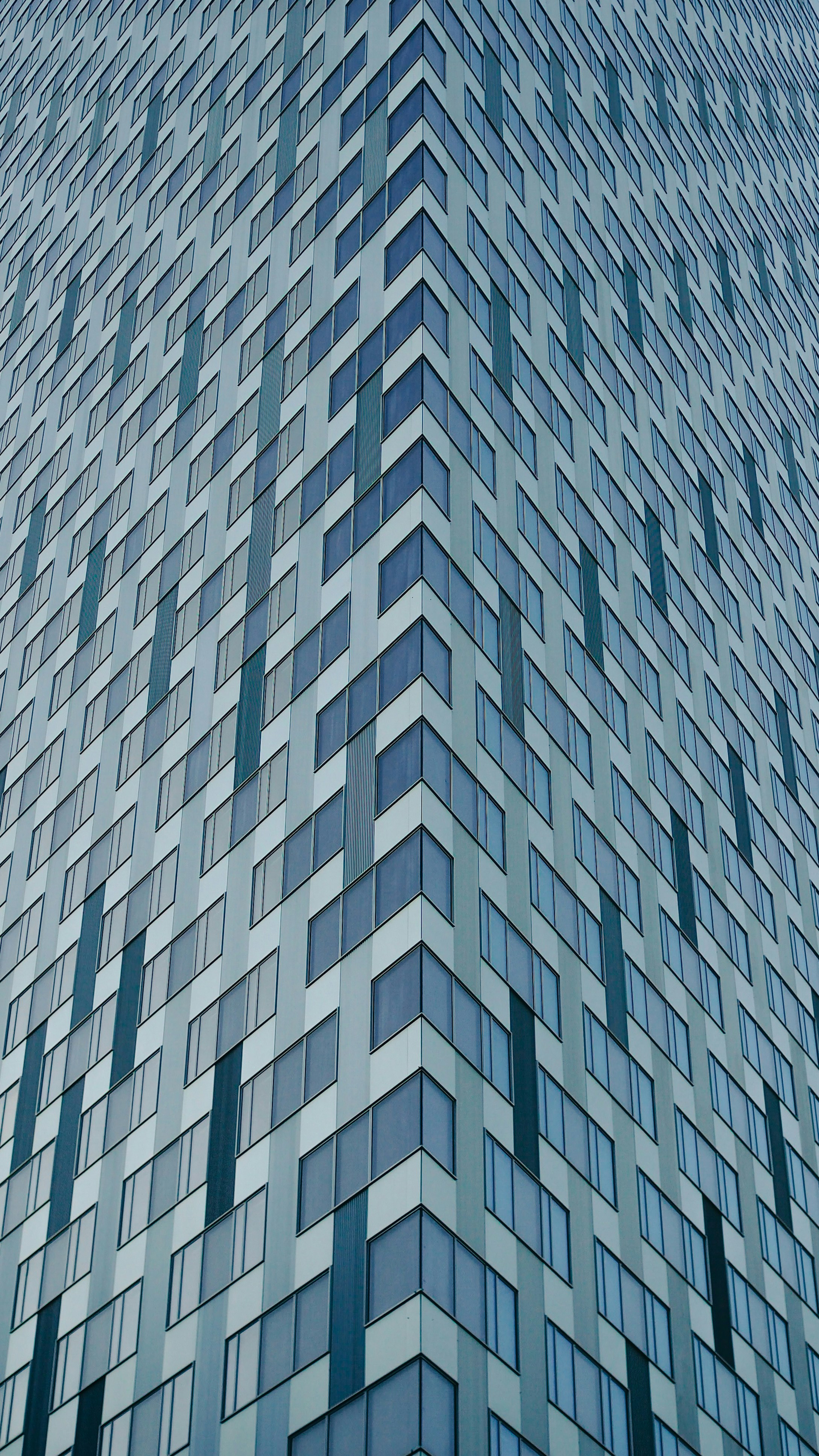 Chevron Facade: A Vertical Tapestry of Glass and Light