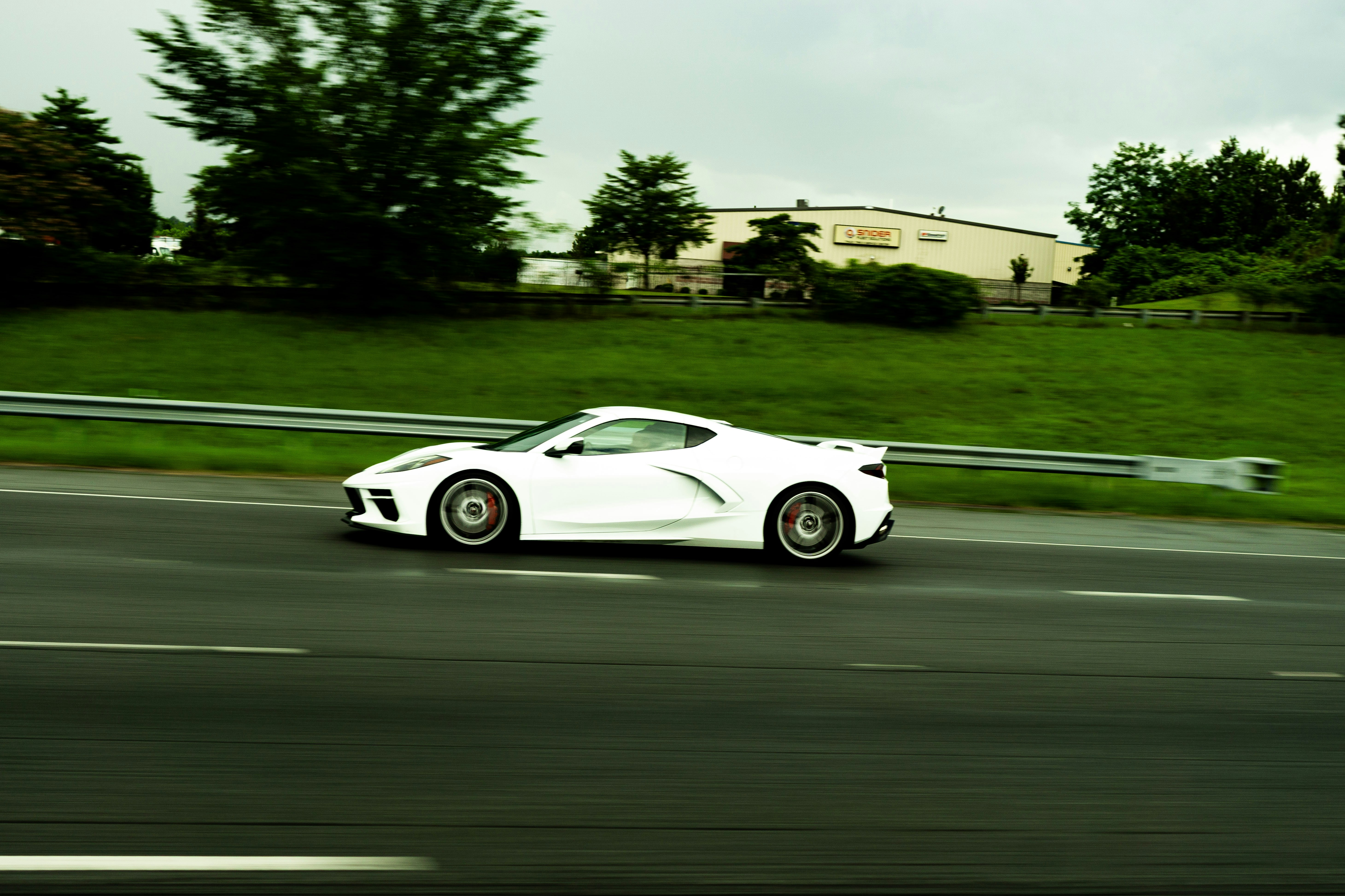 White Hypercar in Motion on an Expressway