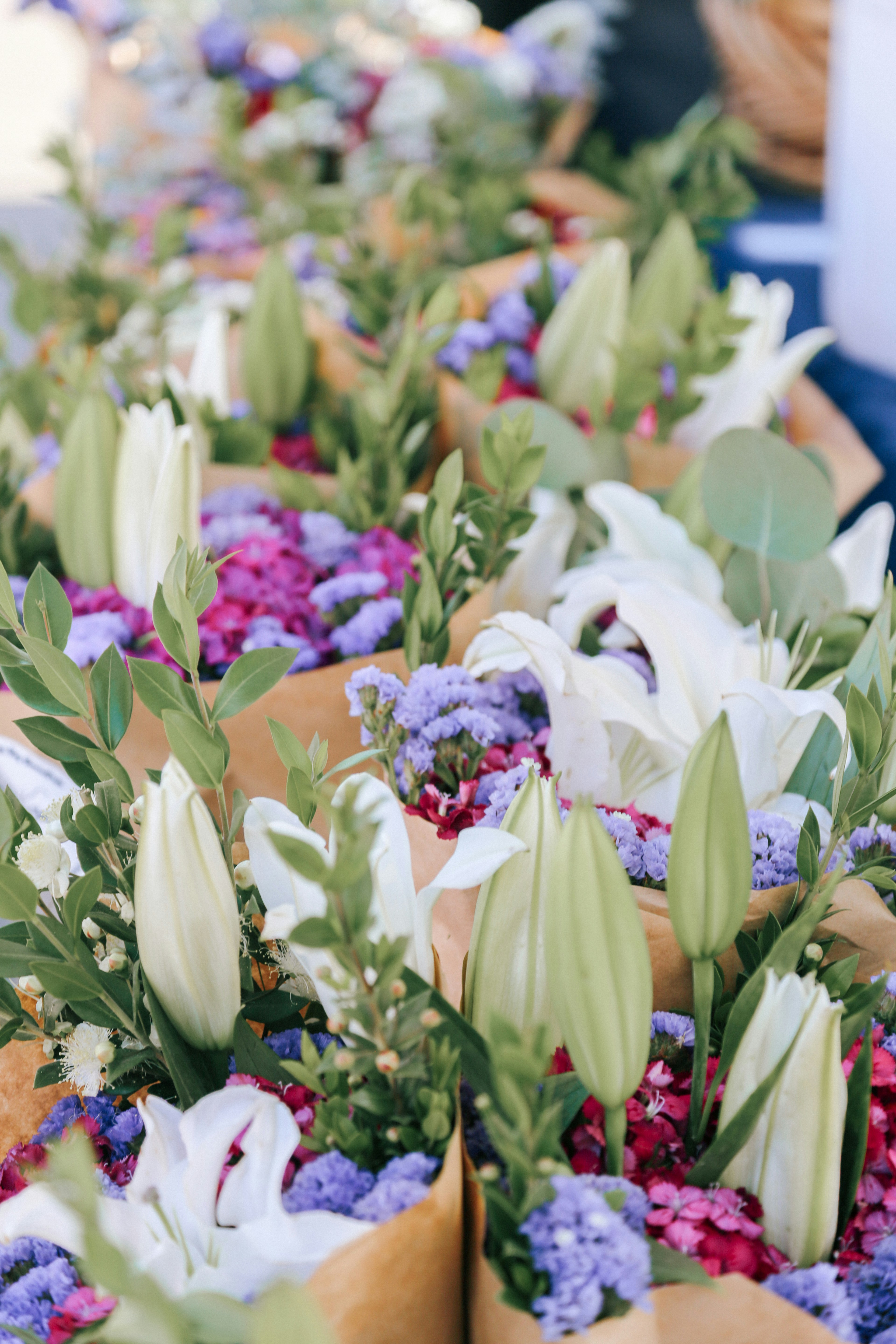 Bouquets in Bloom: White lilies and lavender accents at a street-side flower stand