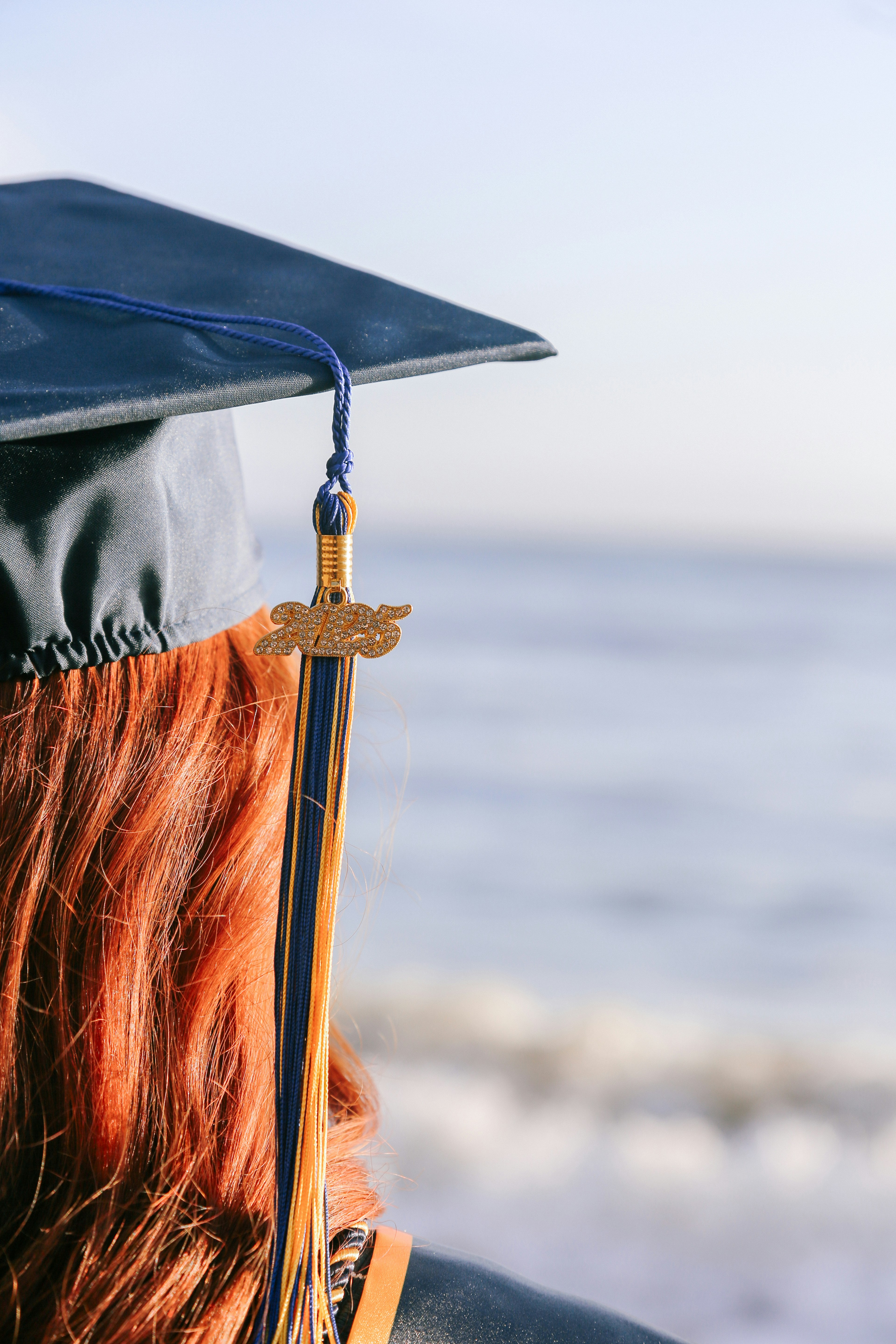 Tassel Tide: A Graduate's Gown by the Seaside Horizon