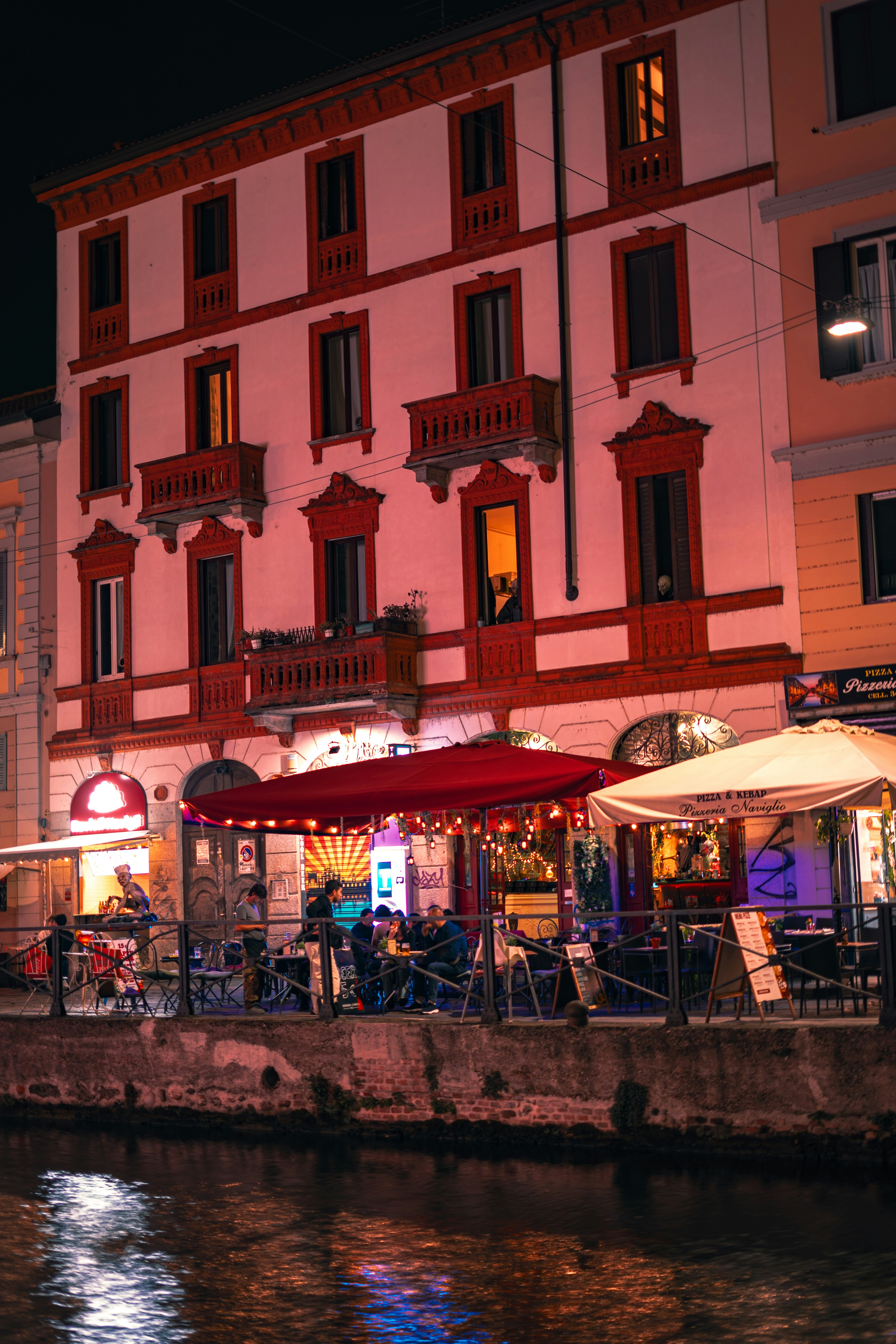 Canton of Nightfall: a riverside café lit by warm parasols
