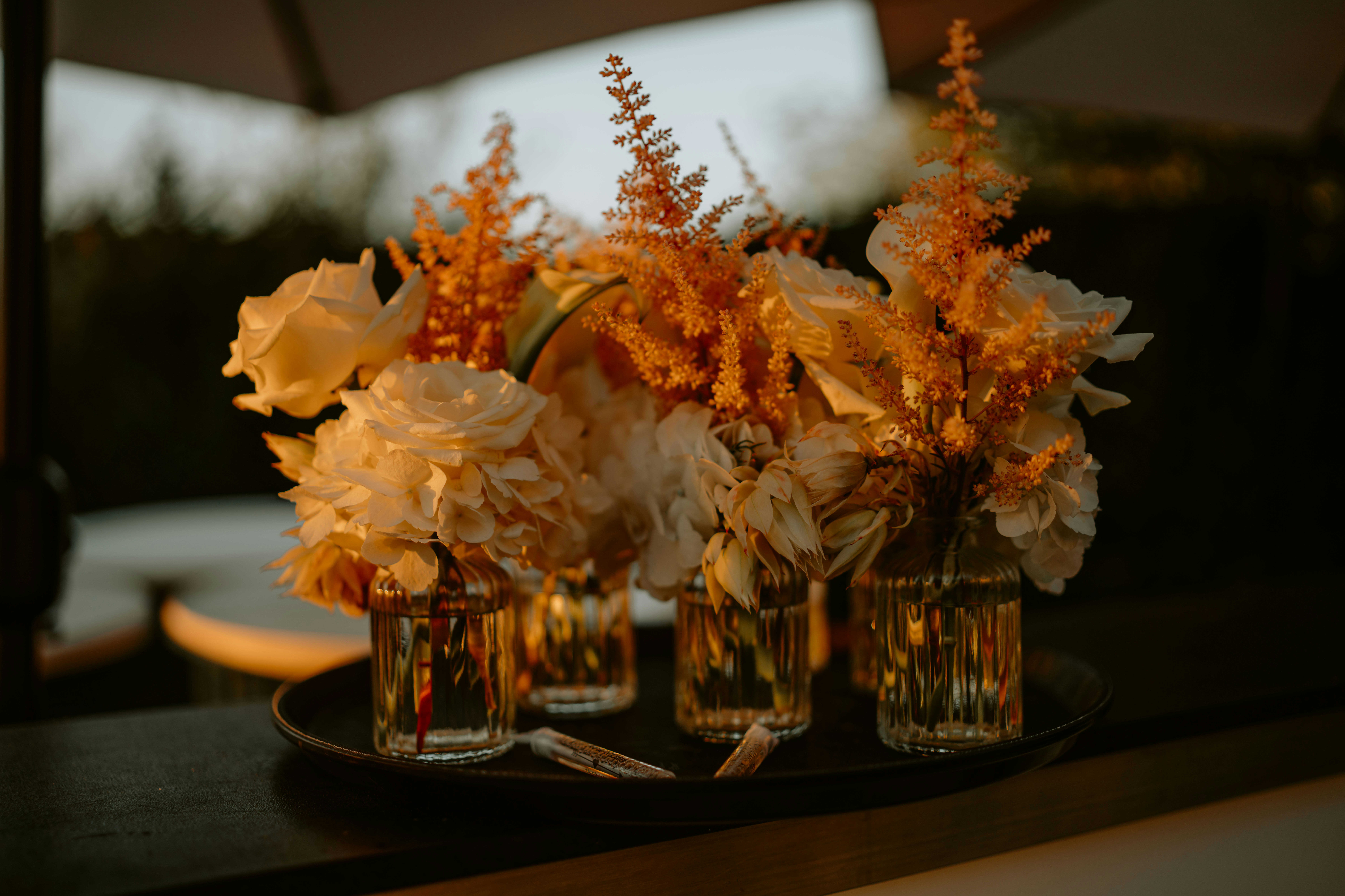 Amber glow on floral centerpiece under patio lights