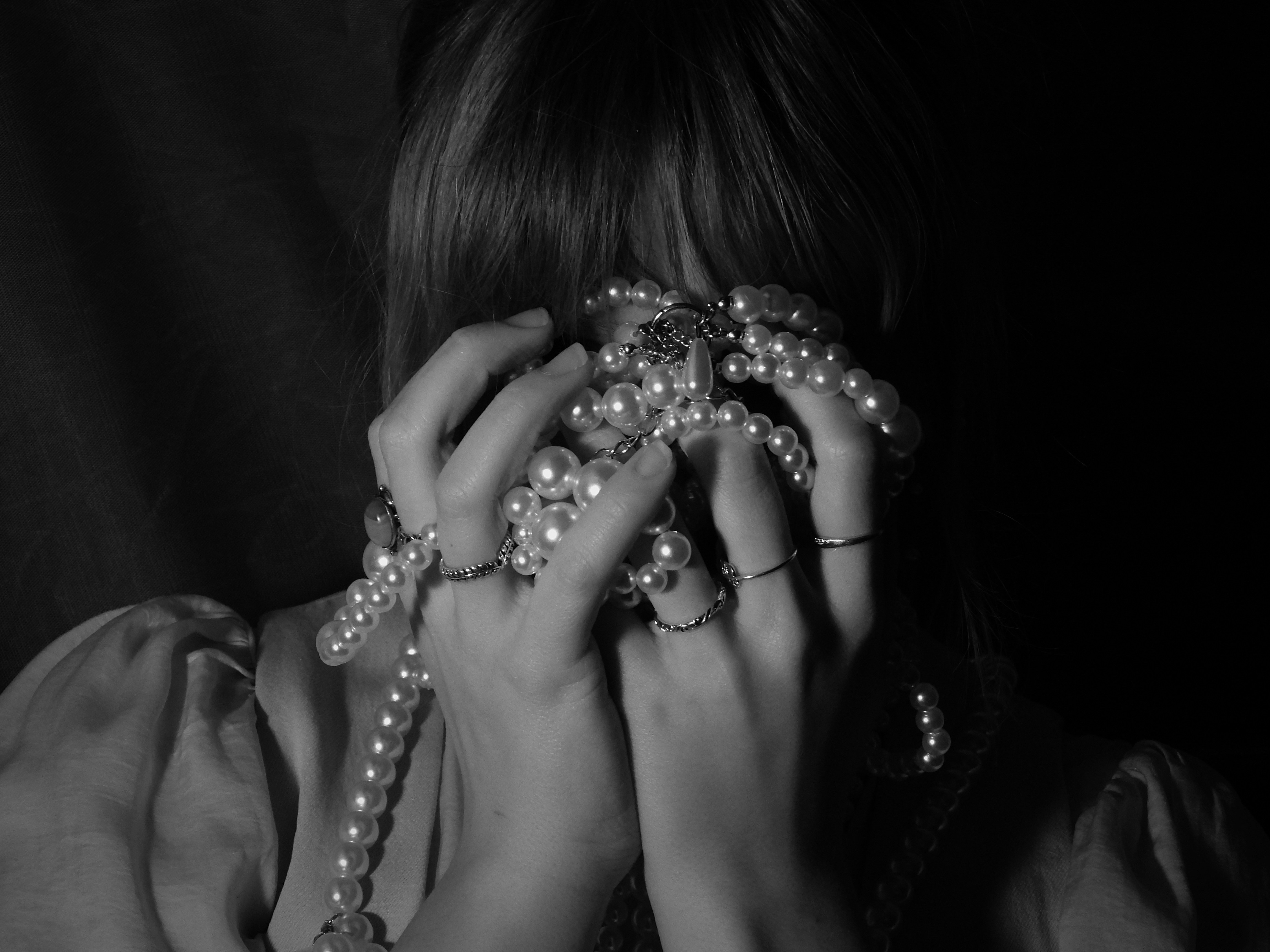 Veiled Gaze: Threaded Pearls Conceal a Quiet Moment