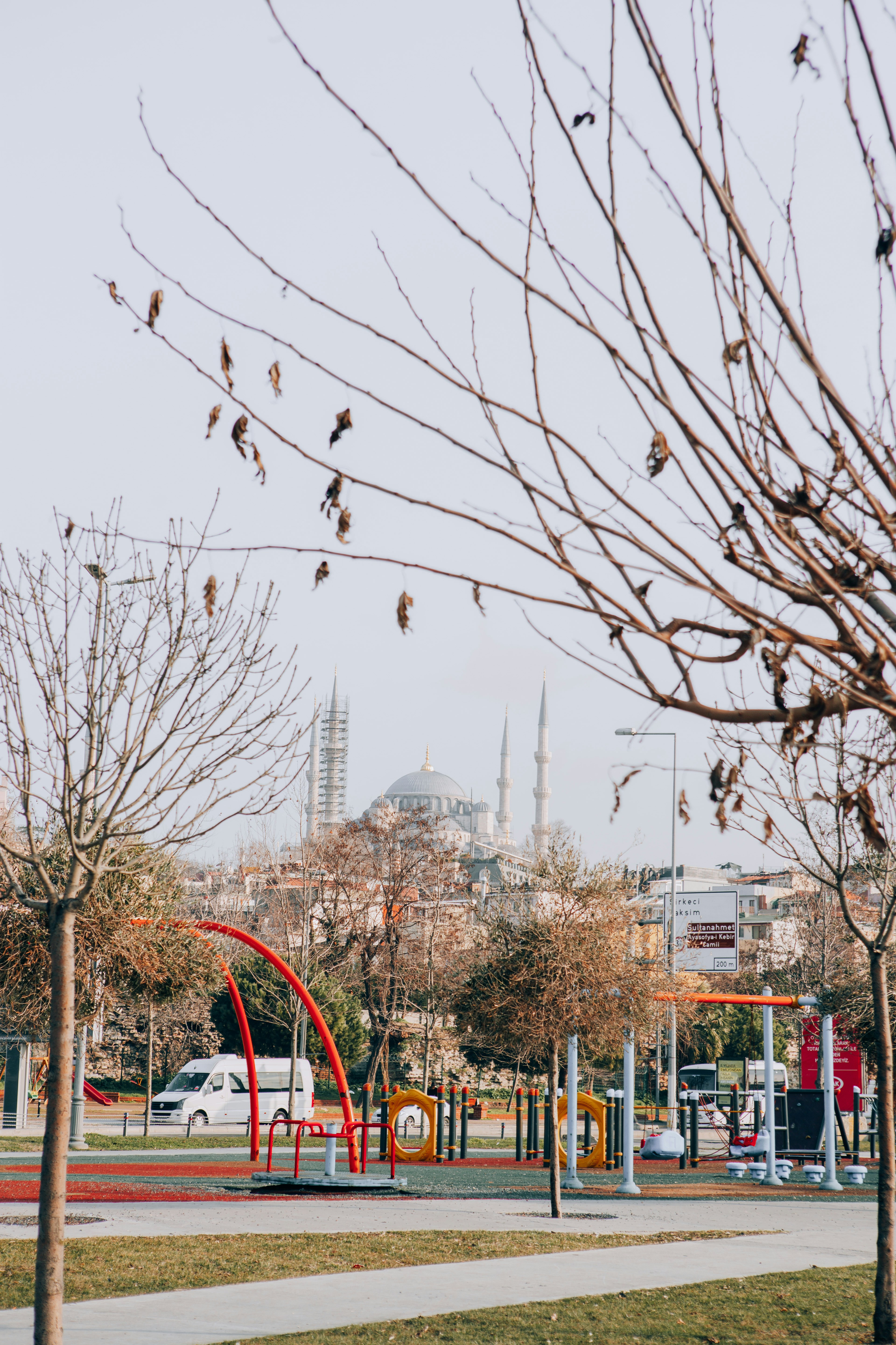 City Park with Mosque Silhouette Behind Bare Winter Trees