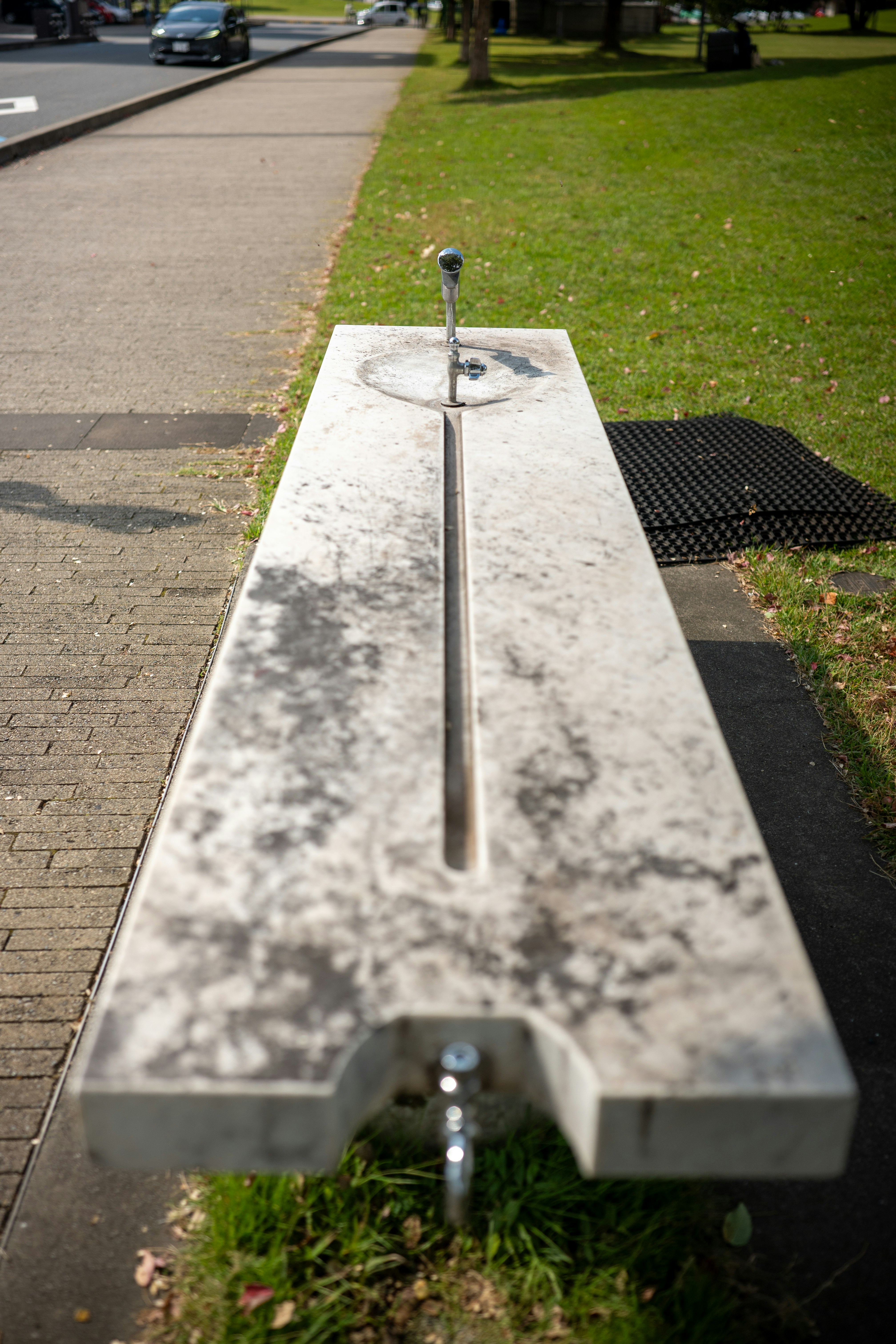 Concrete utility centerpiece along a sunlit park path