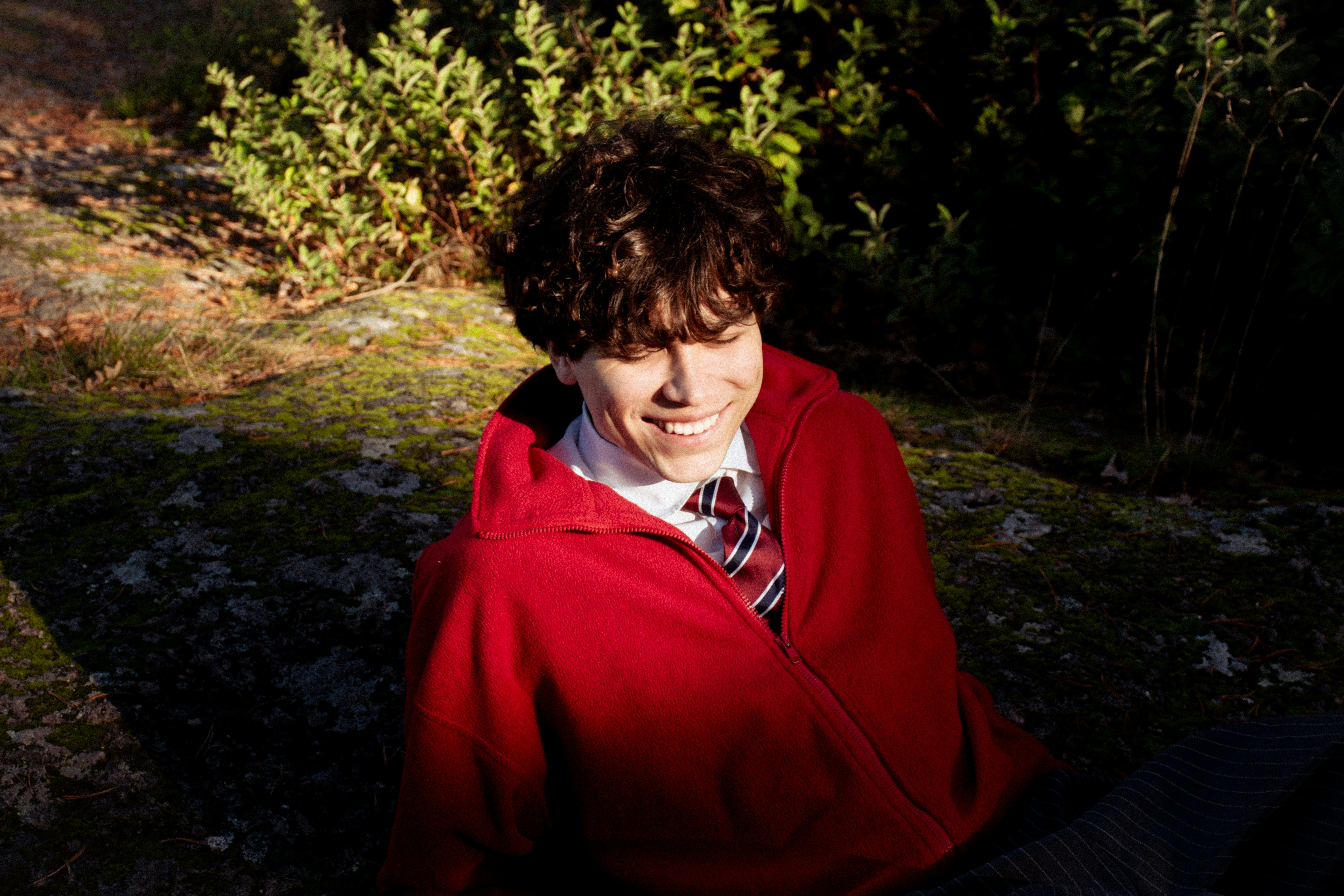 Red-Hooded Portrait in Dappled Outdoors