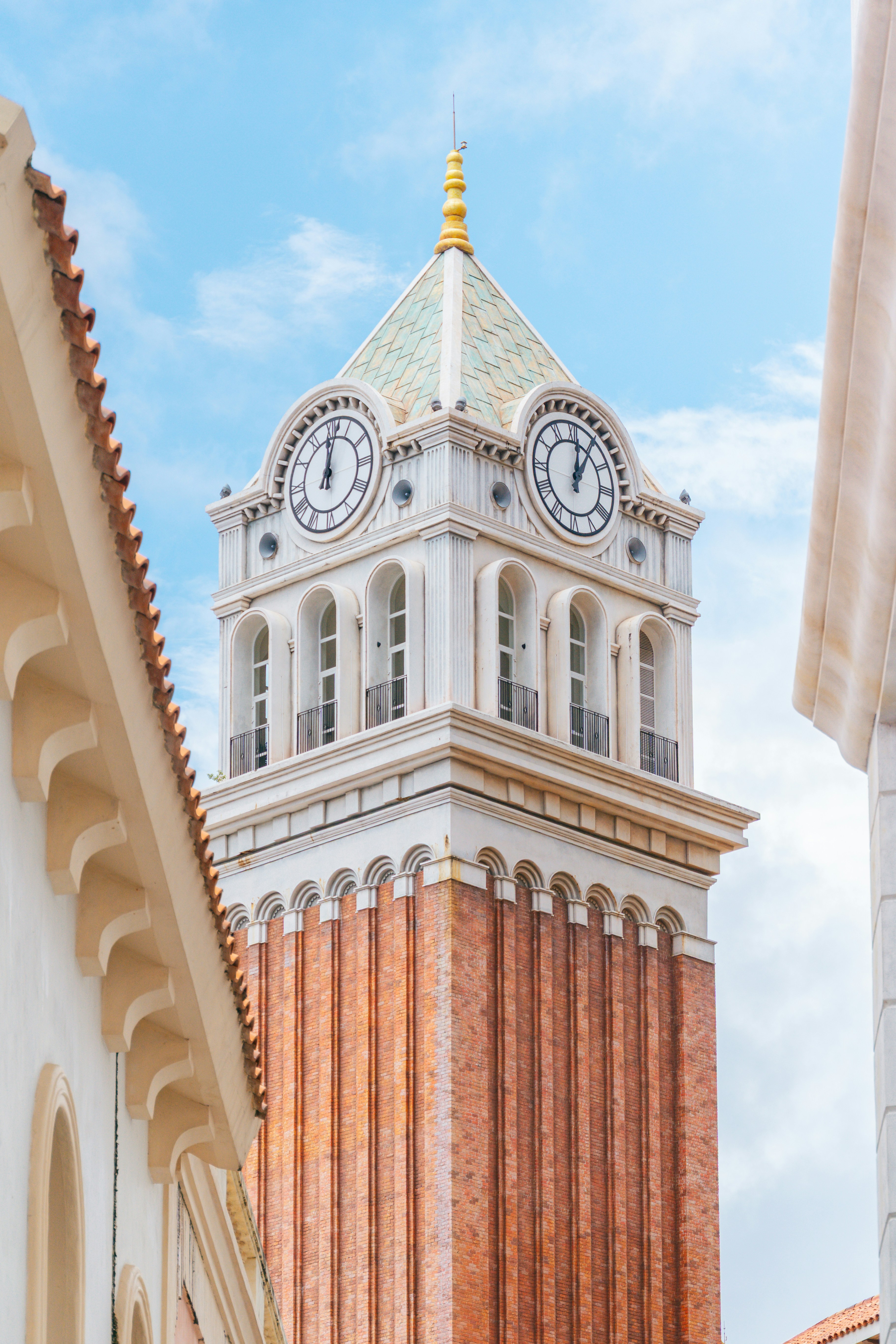 Clocktower Rising: A Sunlit Brick-and-Stone Spire Jarred Between Courtyards