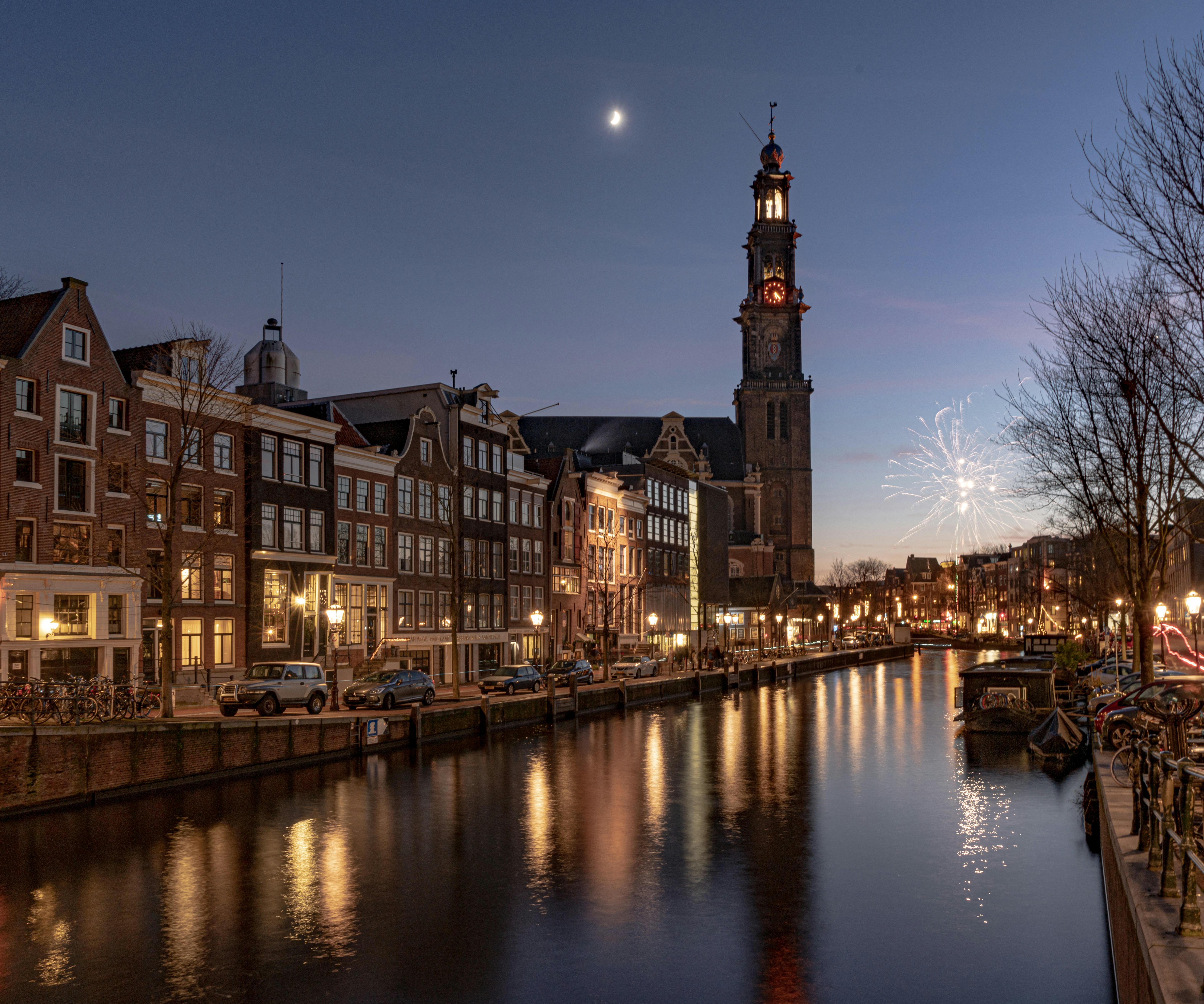 City by the Canal: Evening Glow and Clocktower Reflections