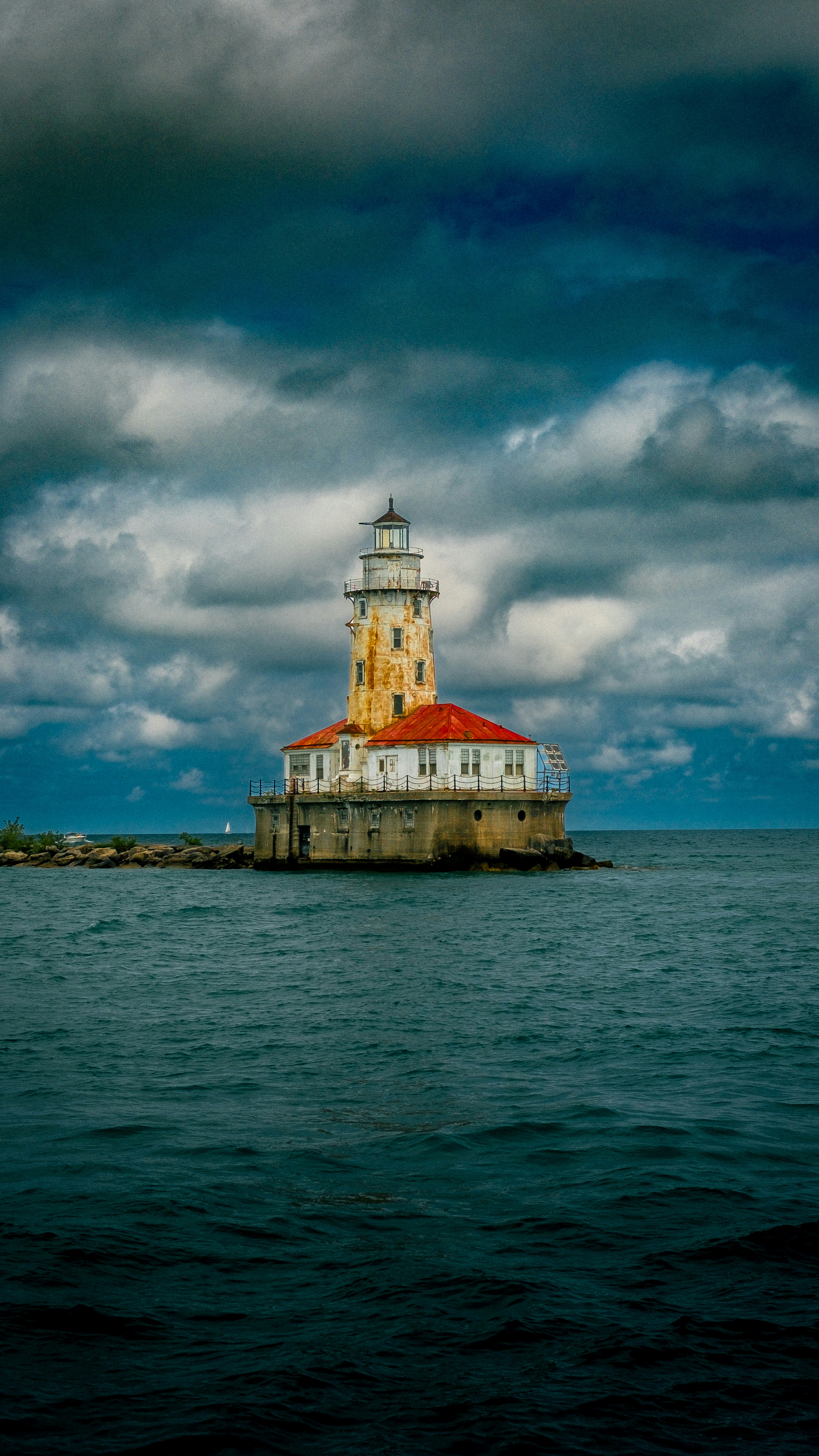 Lighthouse on the Quiet Breakwater under a Tempest Sky