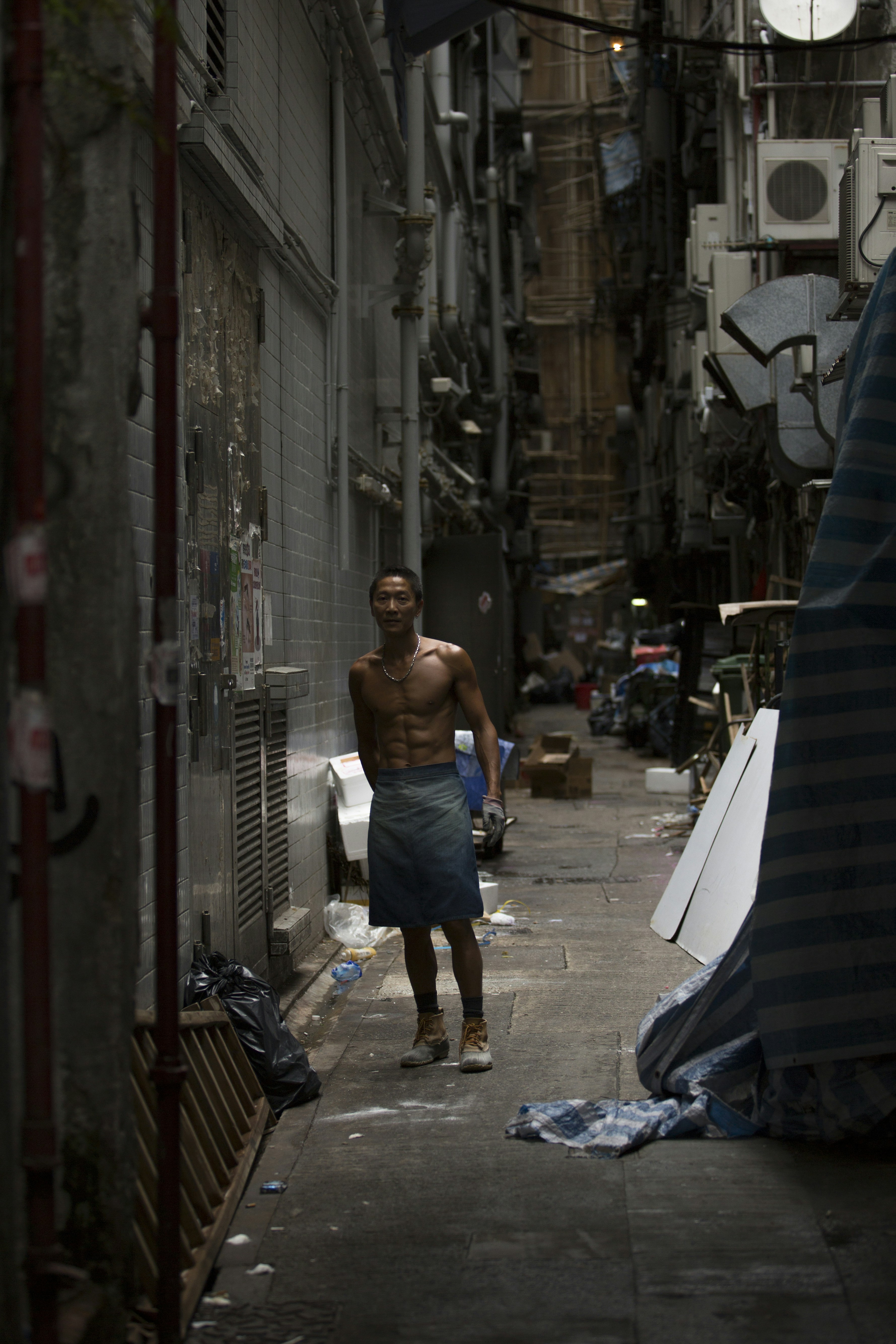 Muscular silhouette in a crowded alleyway