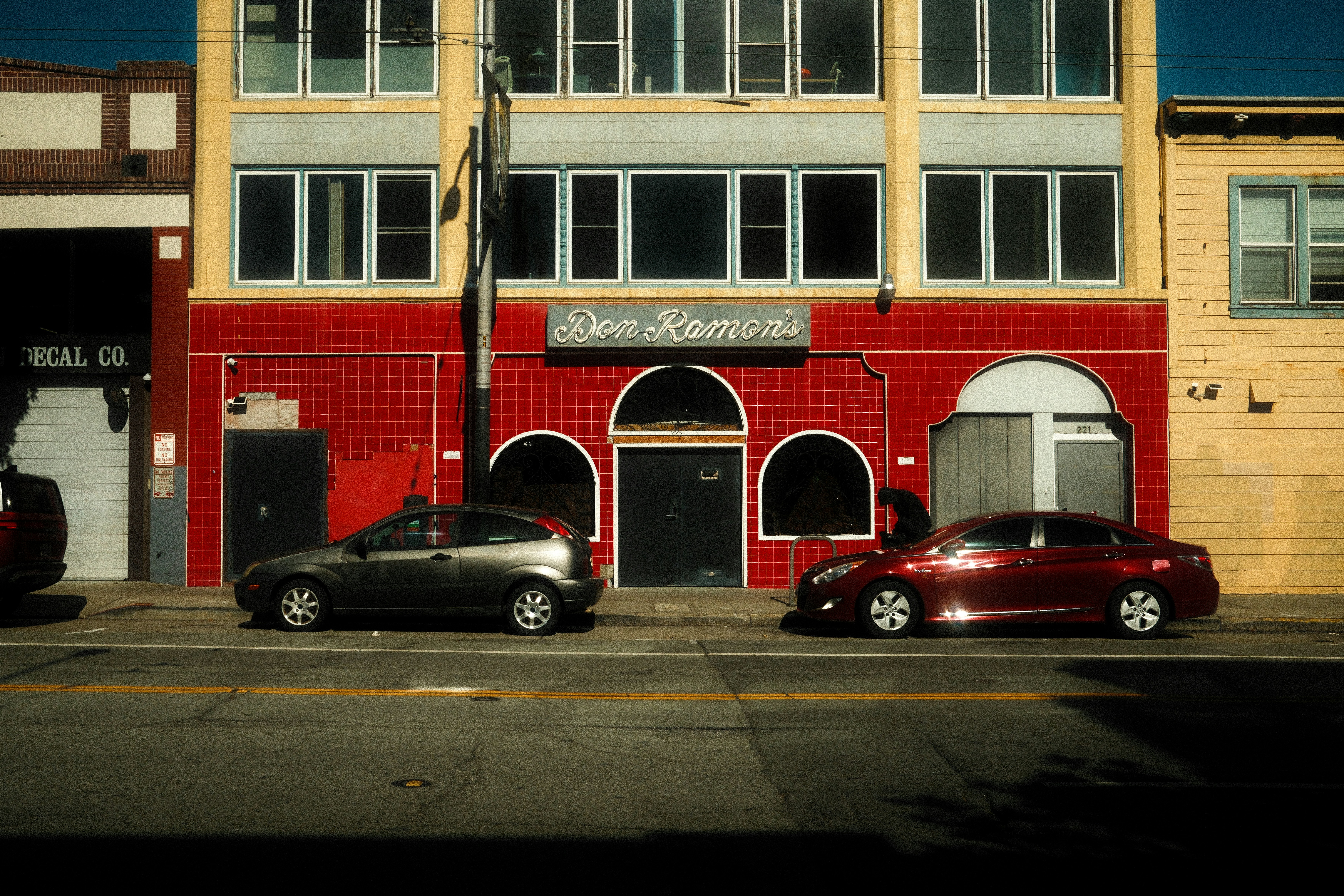 Red Brick Oasis: Don Romero’s Facade Graced by Evening Light