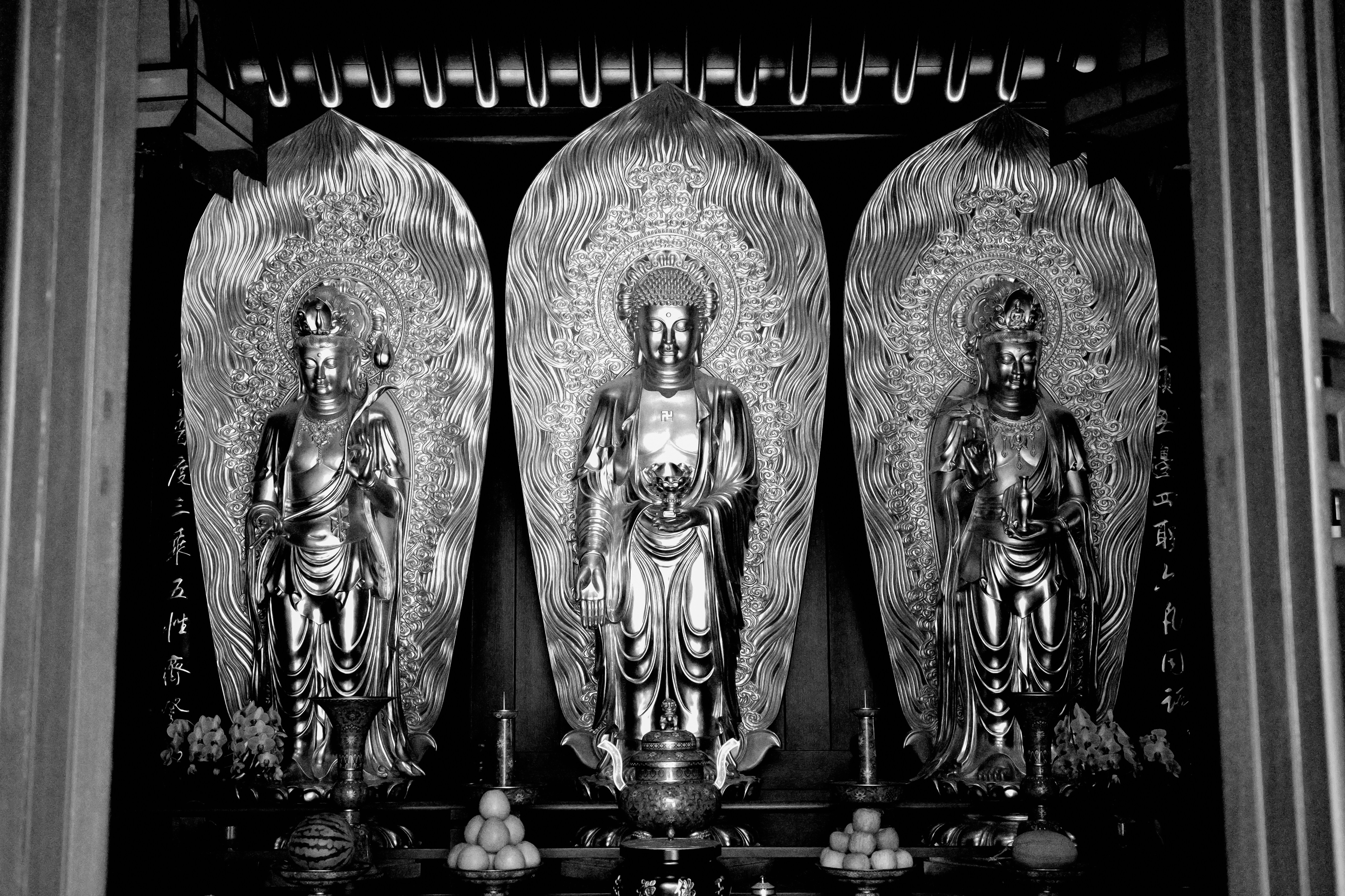 Trio of Enlightened Figures: A Central Shrine in Monochrome Serenity
