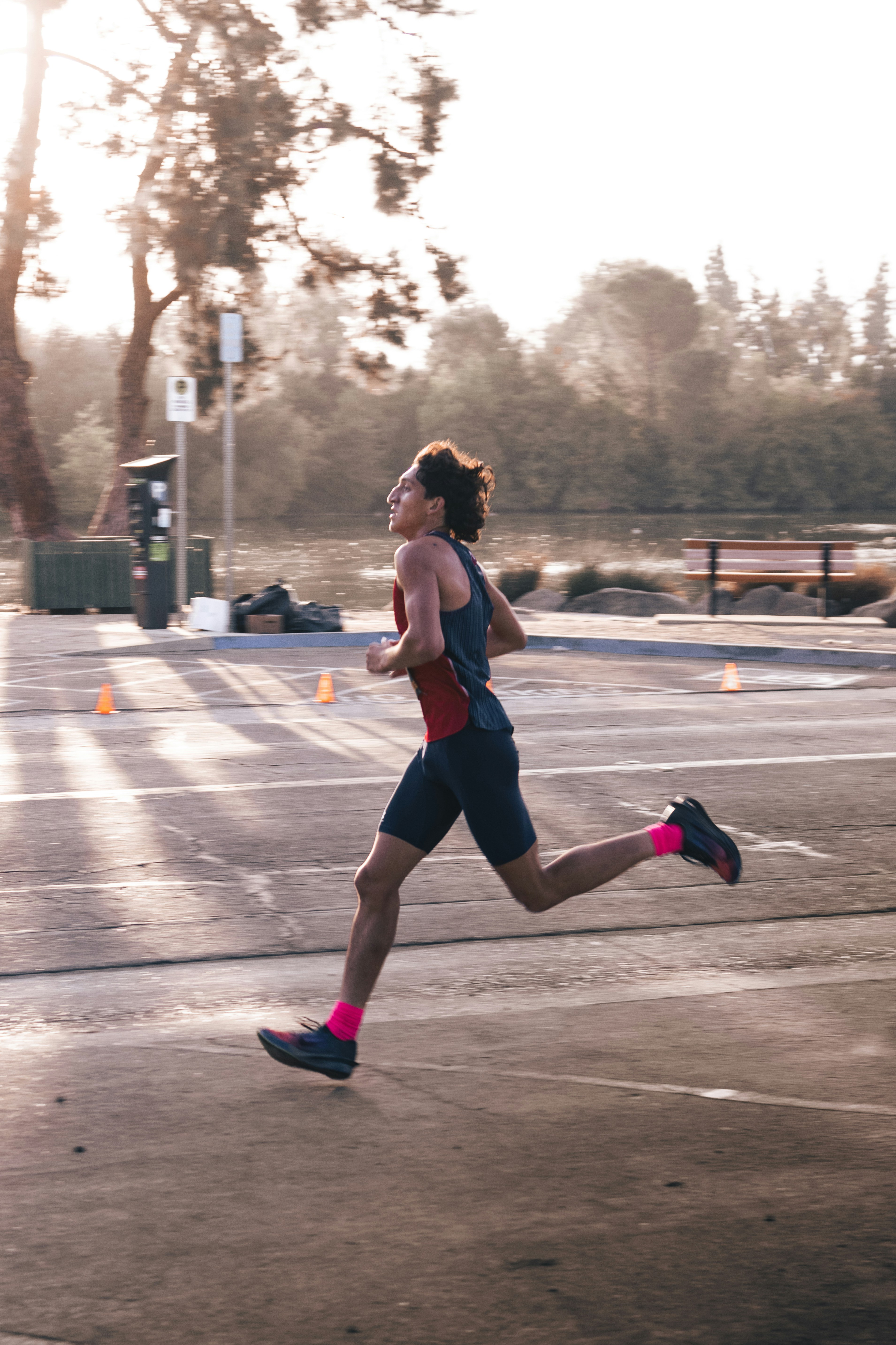 Stride in the Park: A Runner Dashes Past Morning Light
