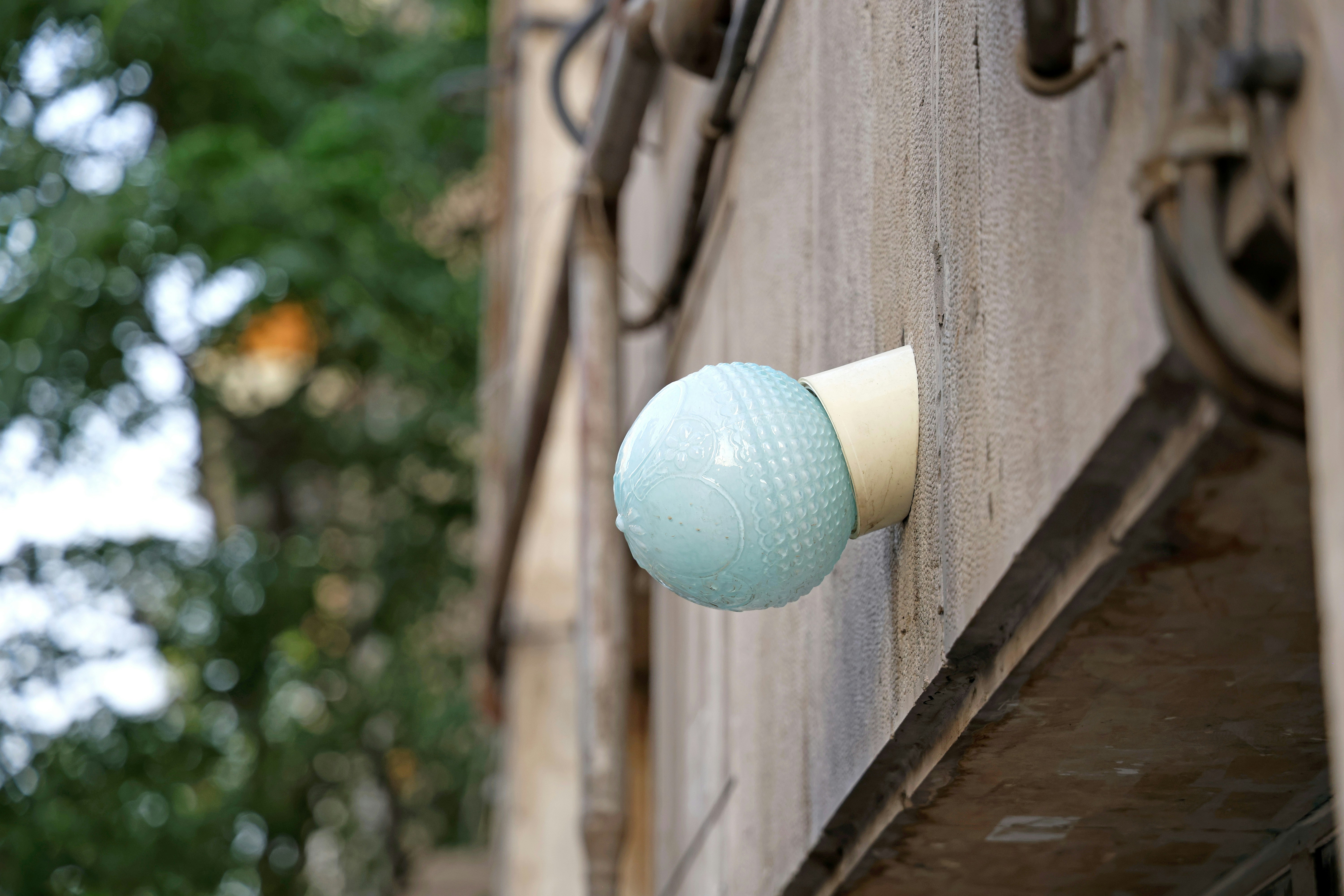 Minted Nightcap on the Wall: A Closeup of an Exterior Light Fixture