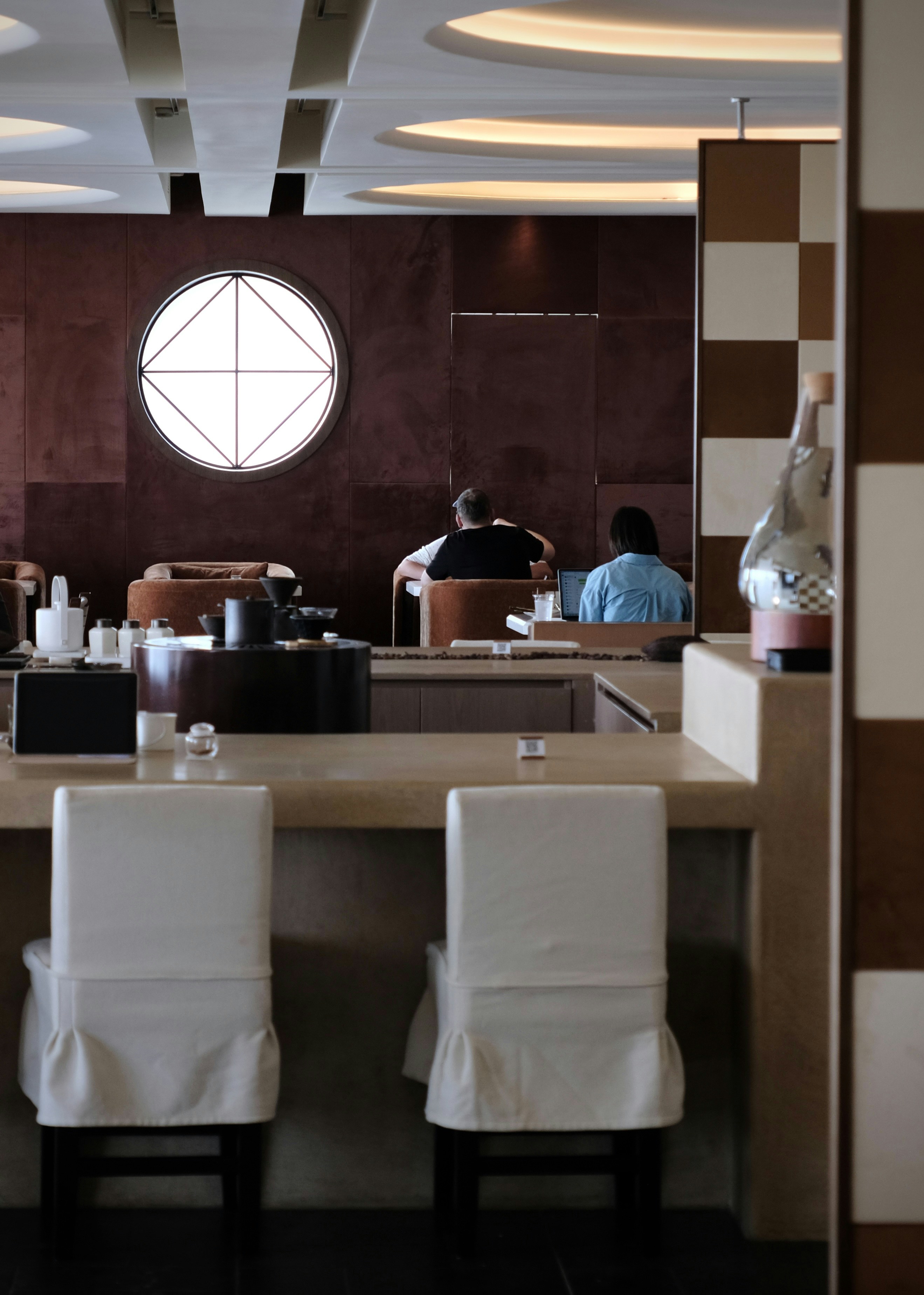 Quiet Corner: Two Guests in a Lantern-Lit Lounge