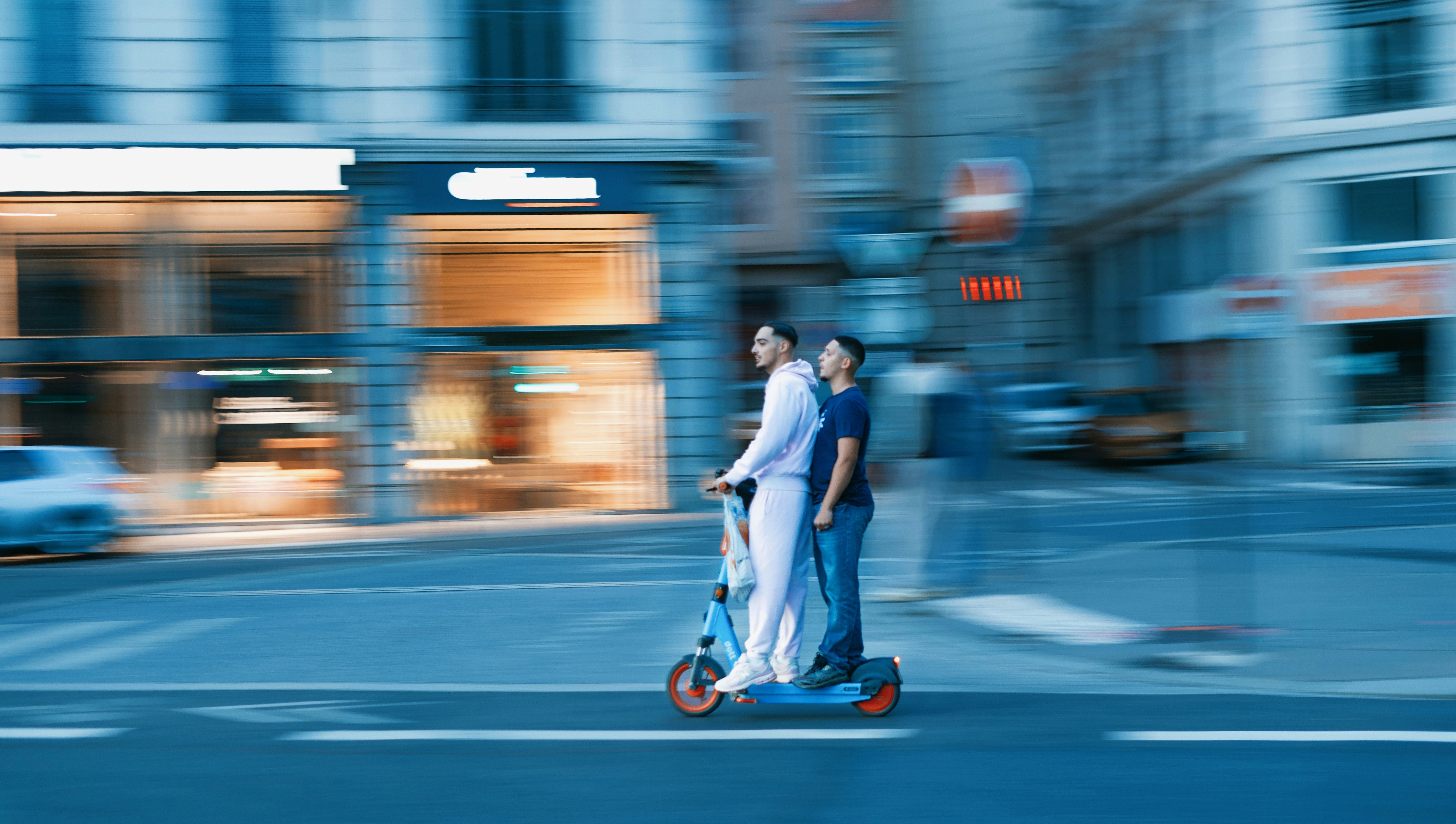 Urban duo on a blue-sky glide: a blurred city ride