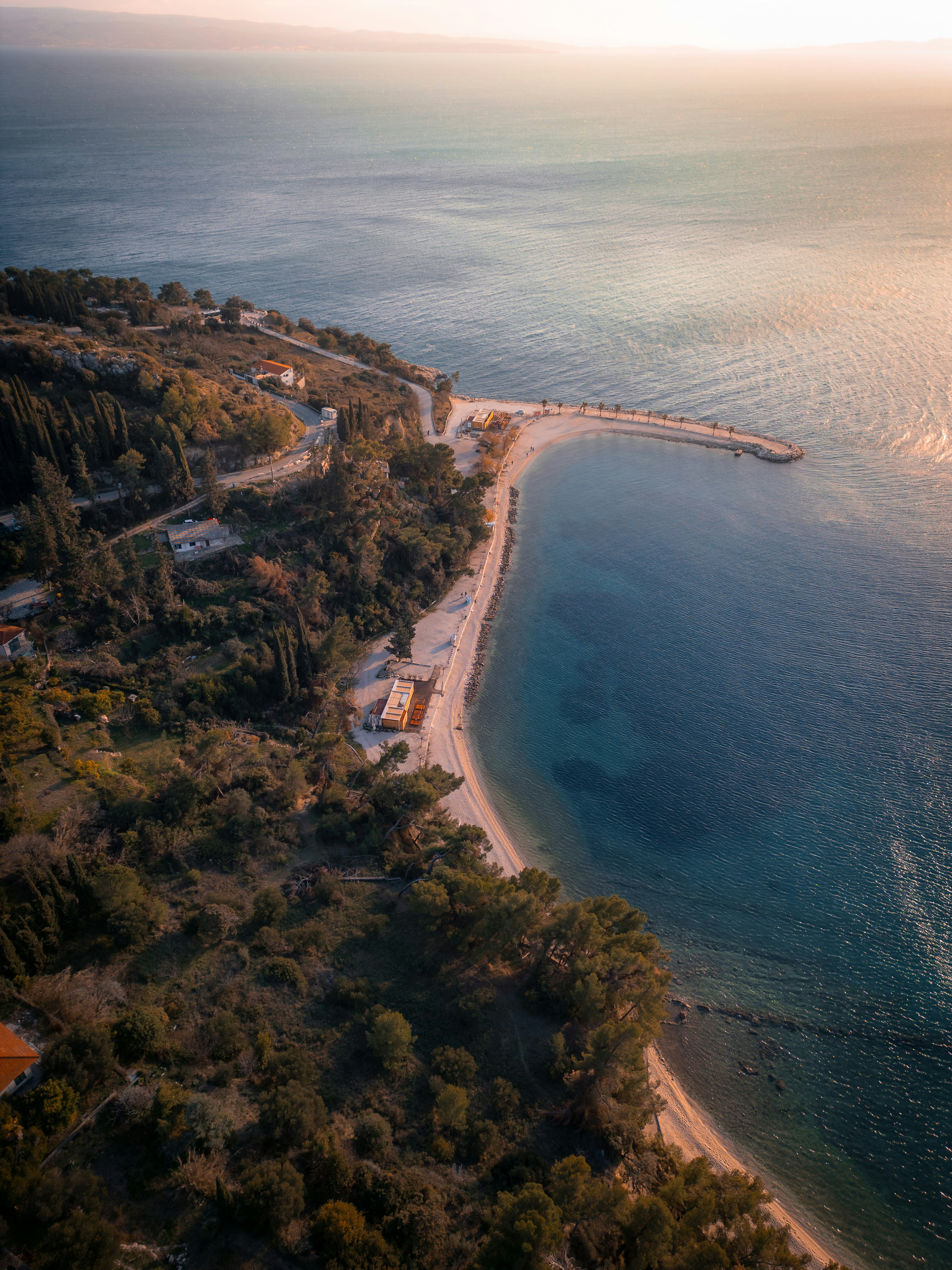 Coastal Promenade: Sunset Light over a Serene Cove
