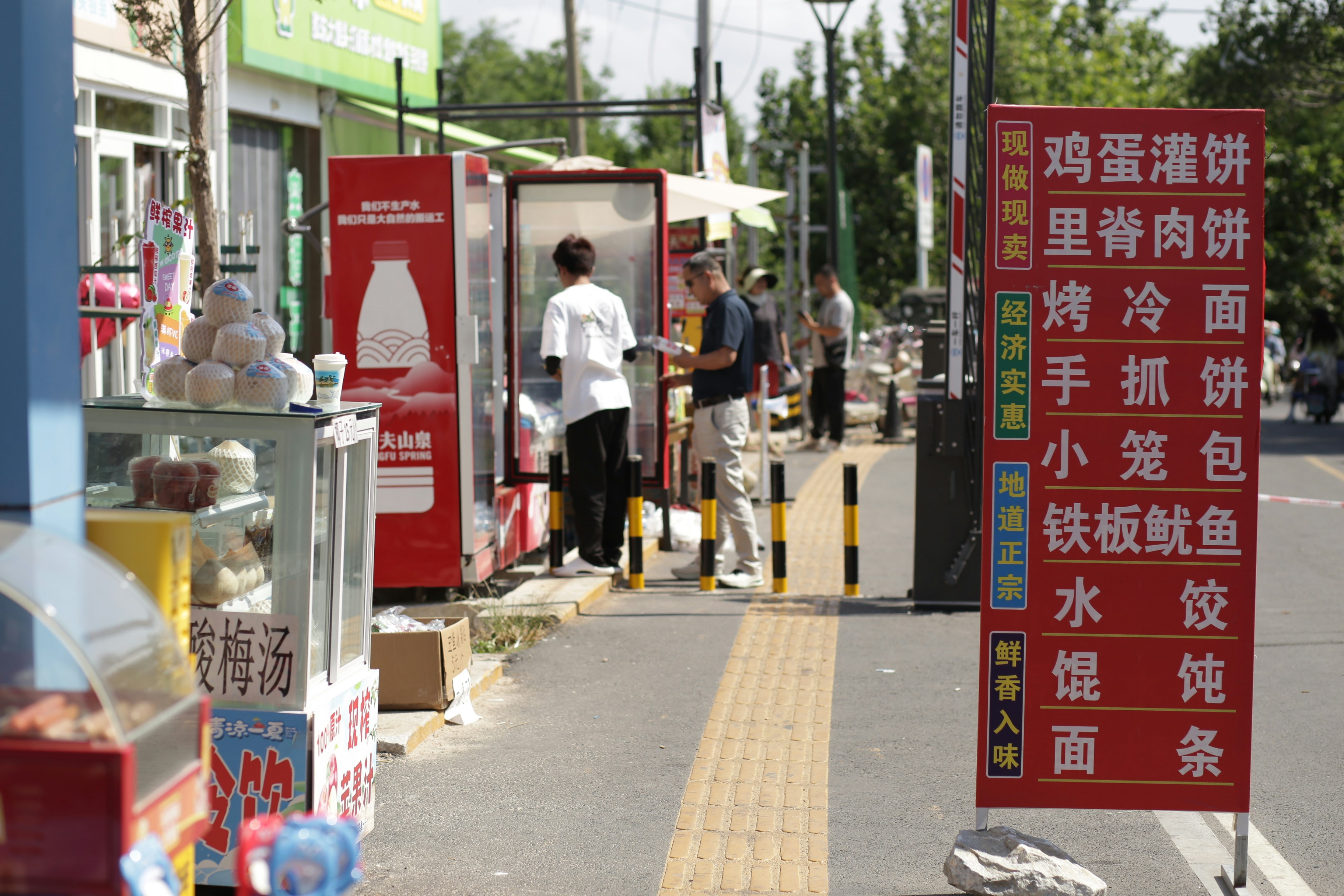 Market Entrance: A Busy Street Food Stand Framed by Bold Red Signboards