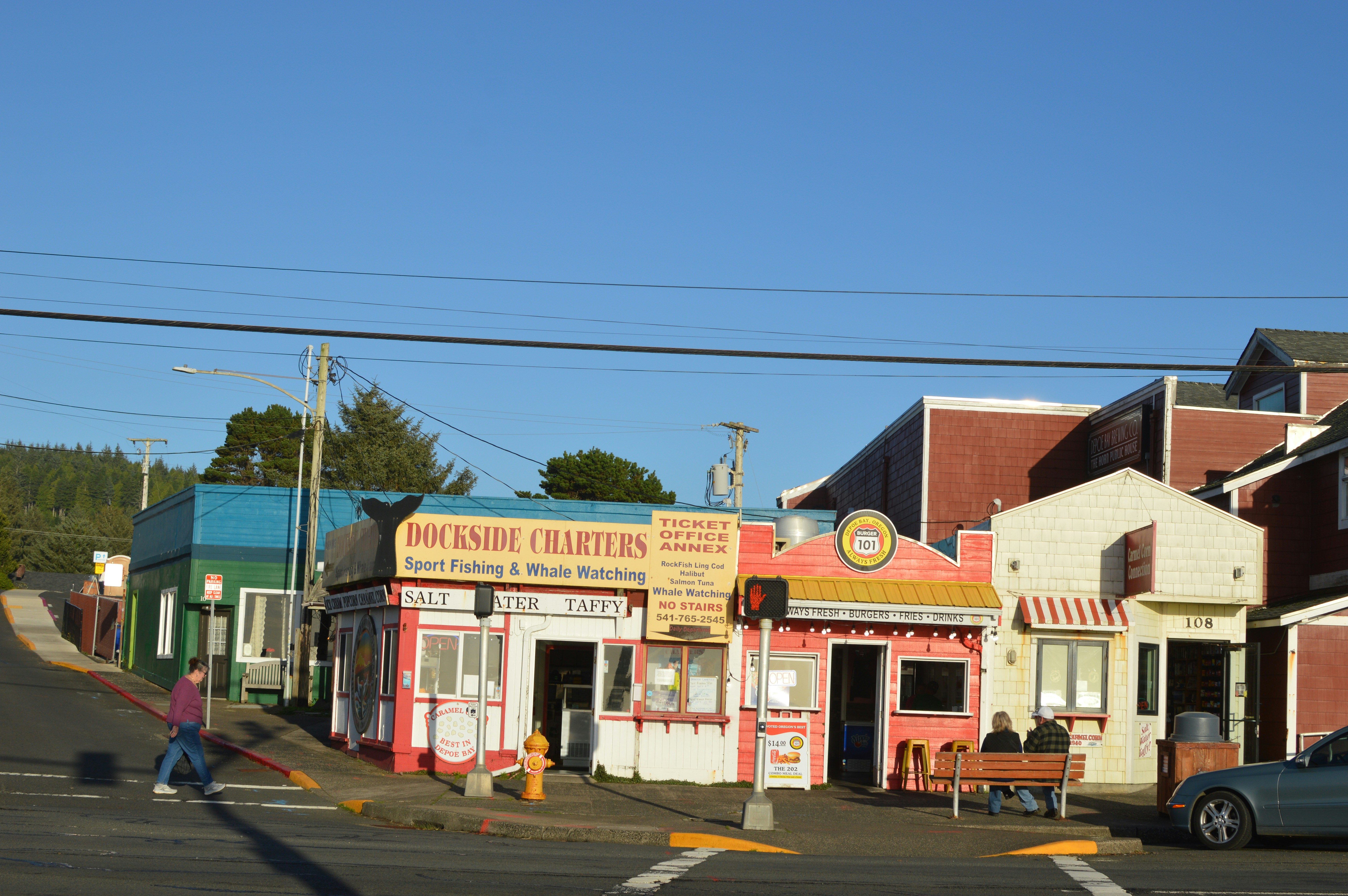 Row of storefronts in a sunny harbor town