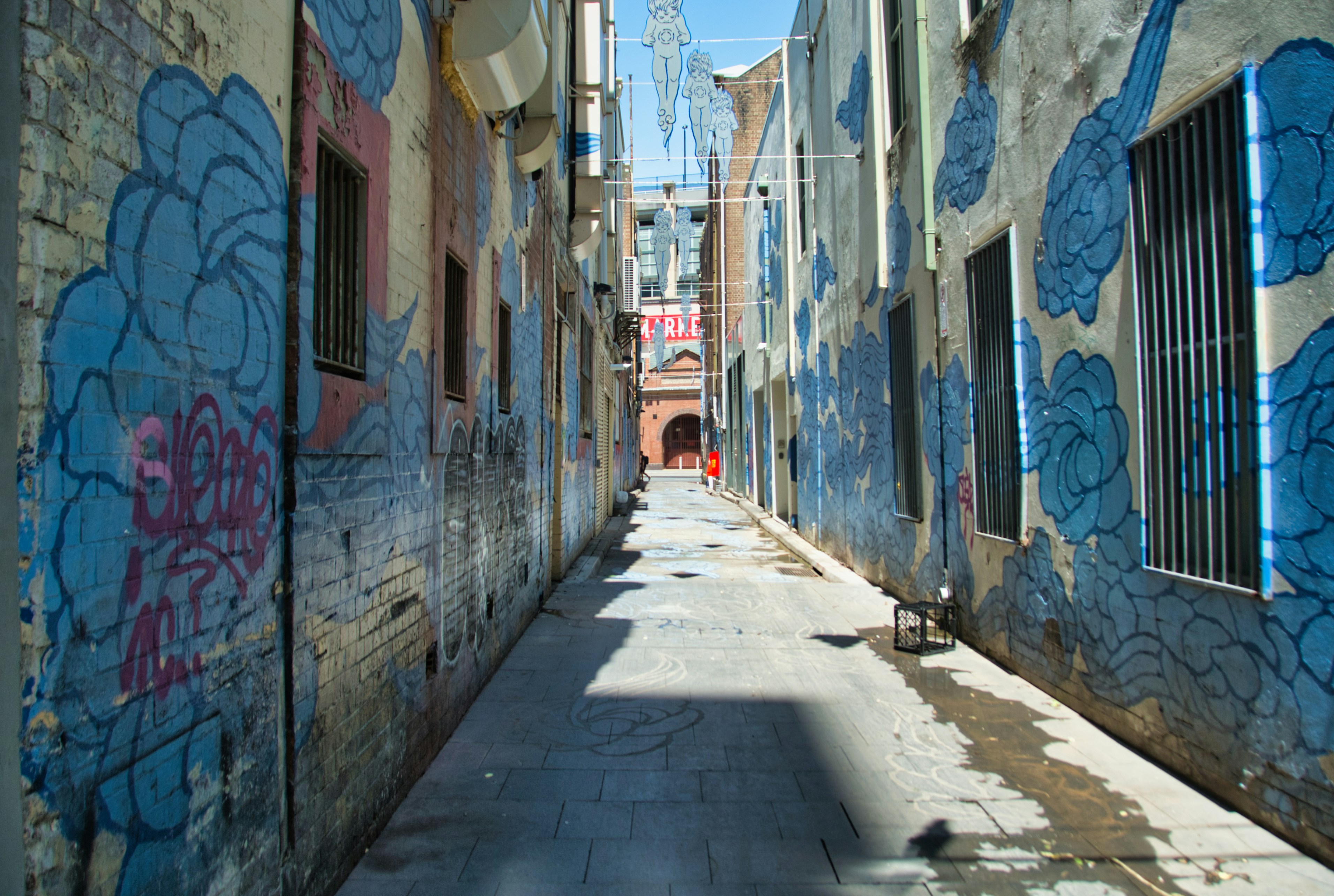 Graffiti Alleyway Leading to a Sunlit Archway