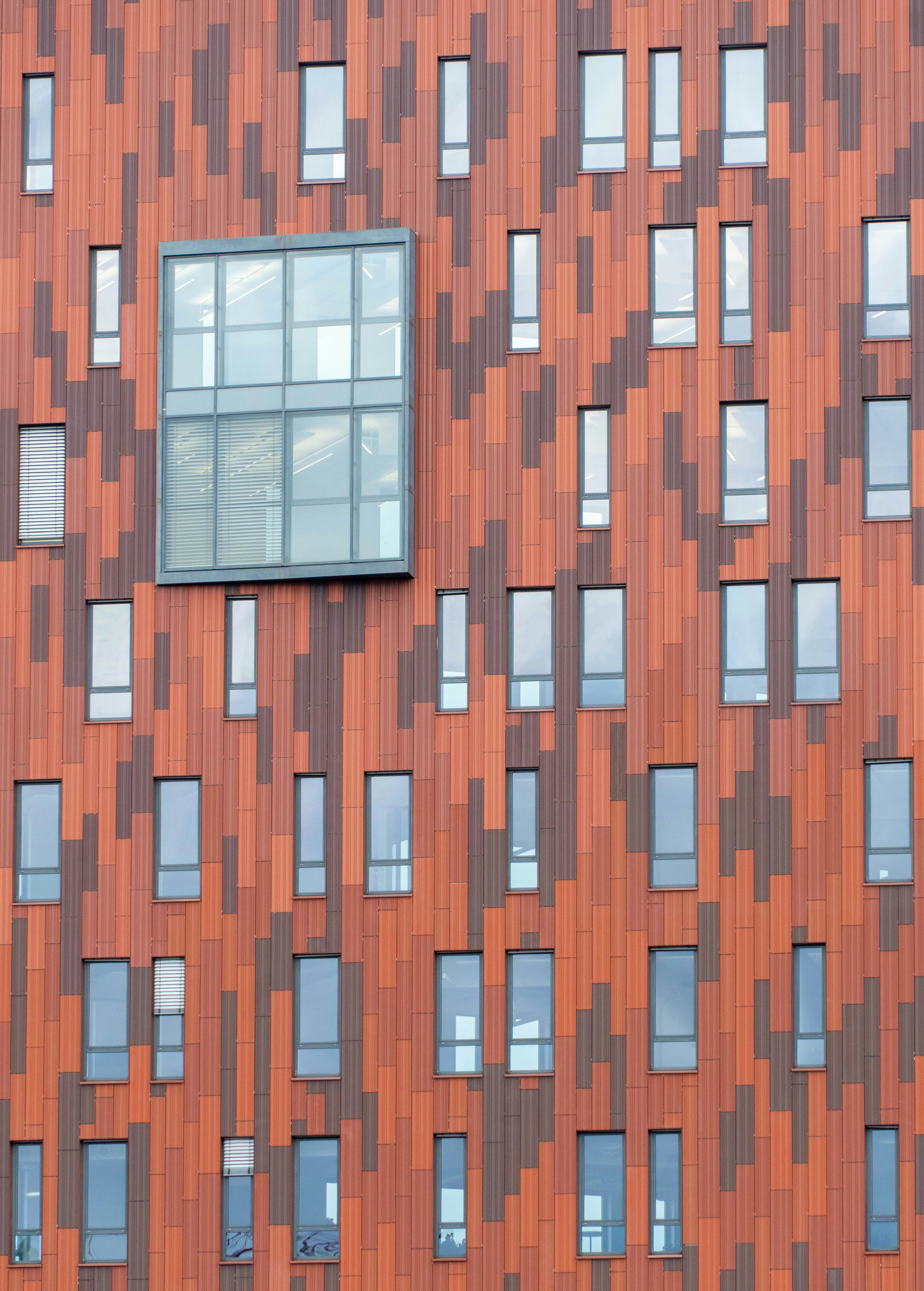 Brickwork Mosaic: A Windowed Facade with a Floating Box