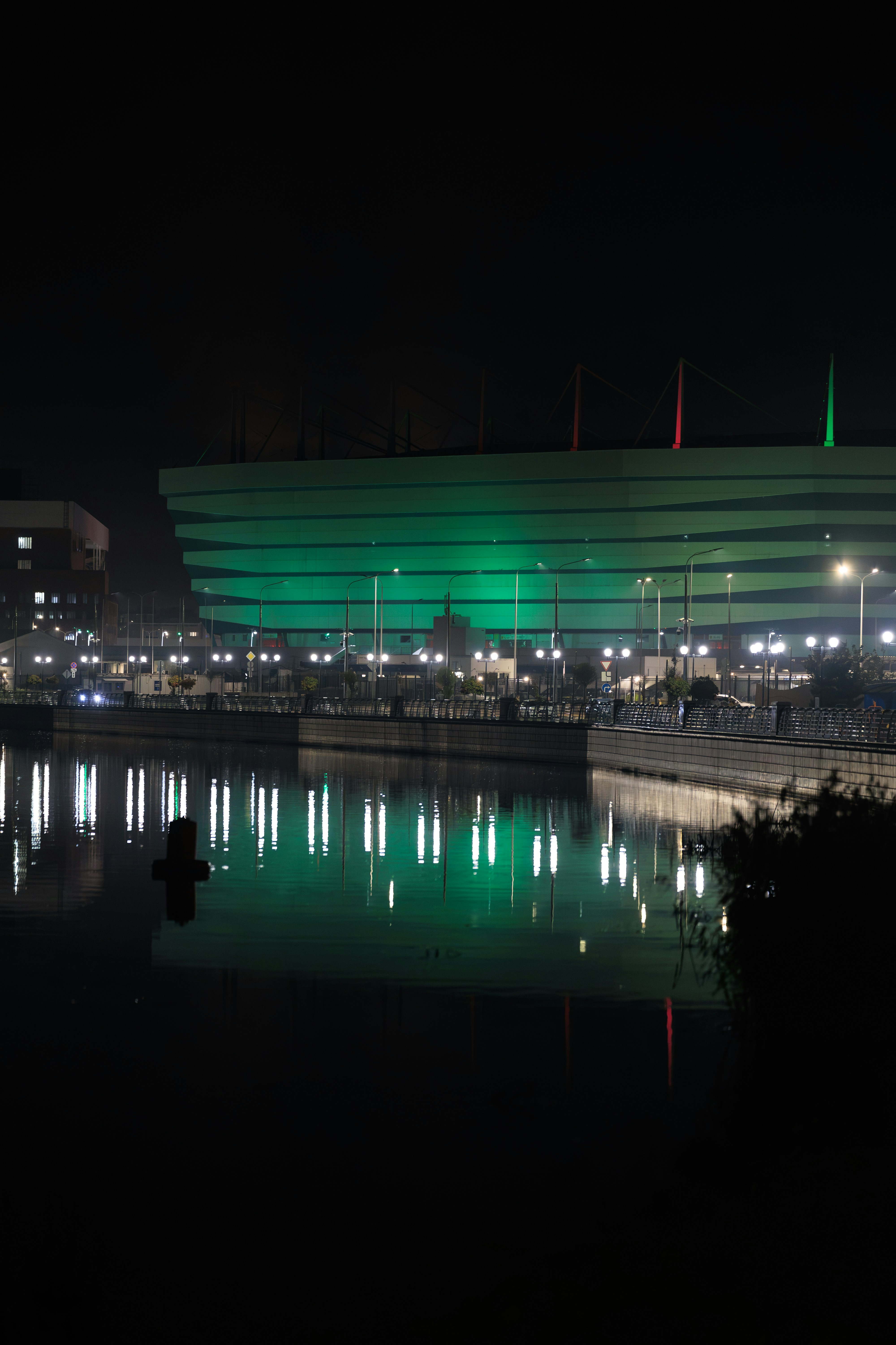 Green Stadium by Night: Reflections Dancing on a Quiet Harbor