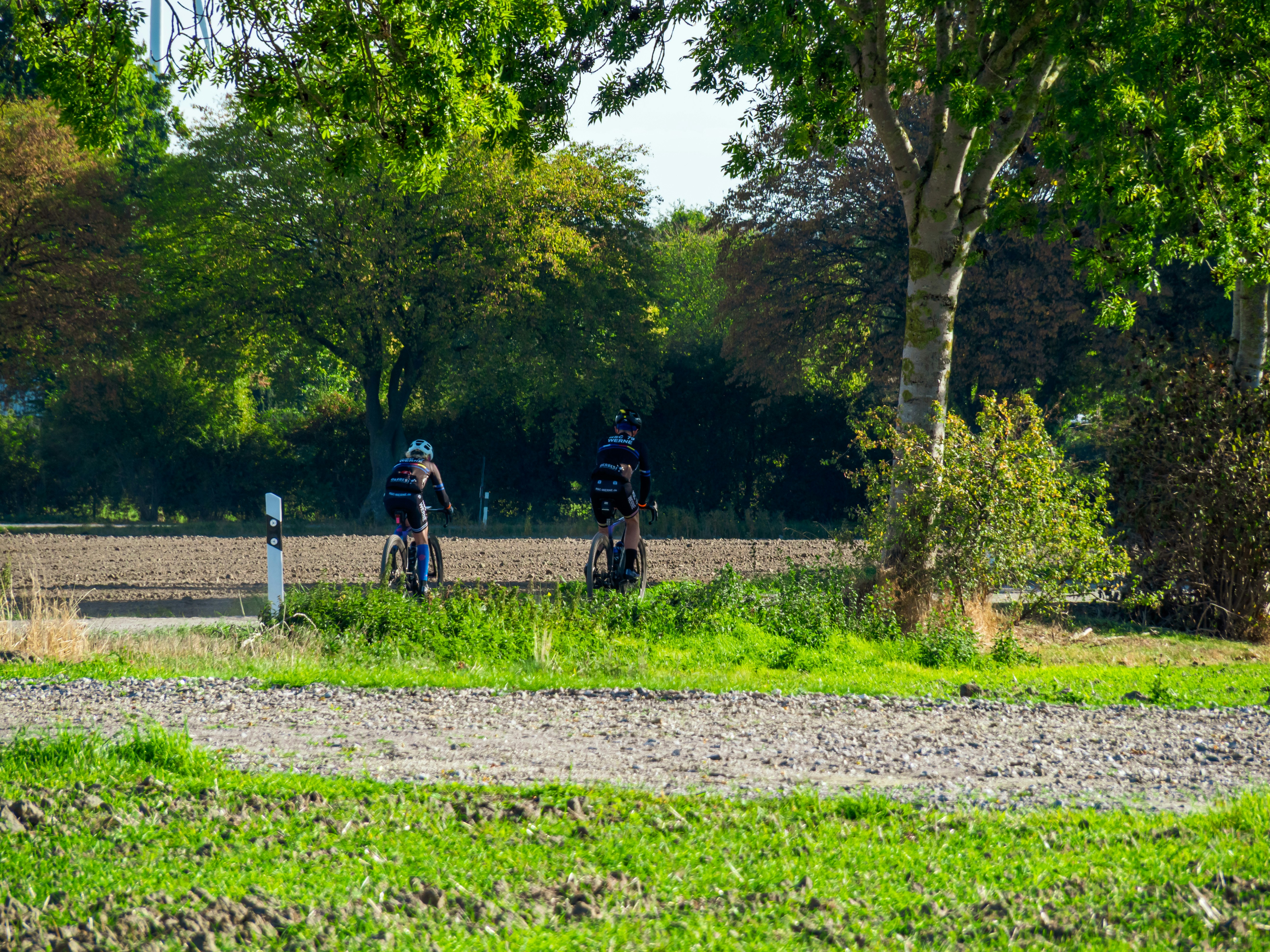 Two Cyclists From a Green Corridor