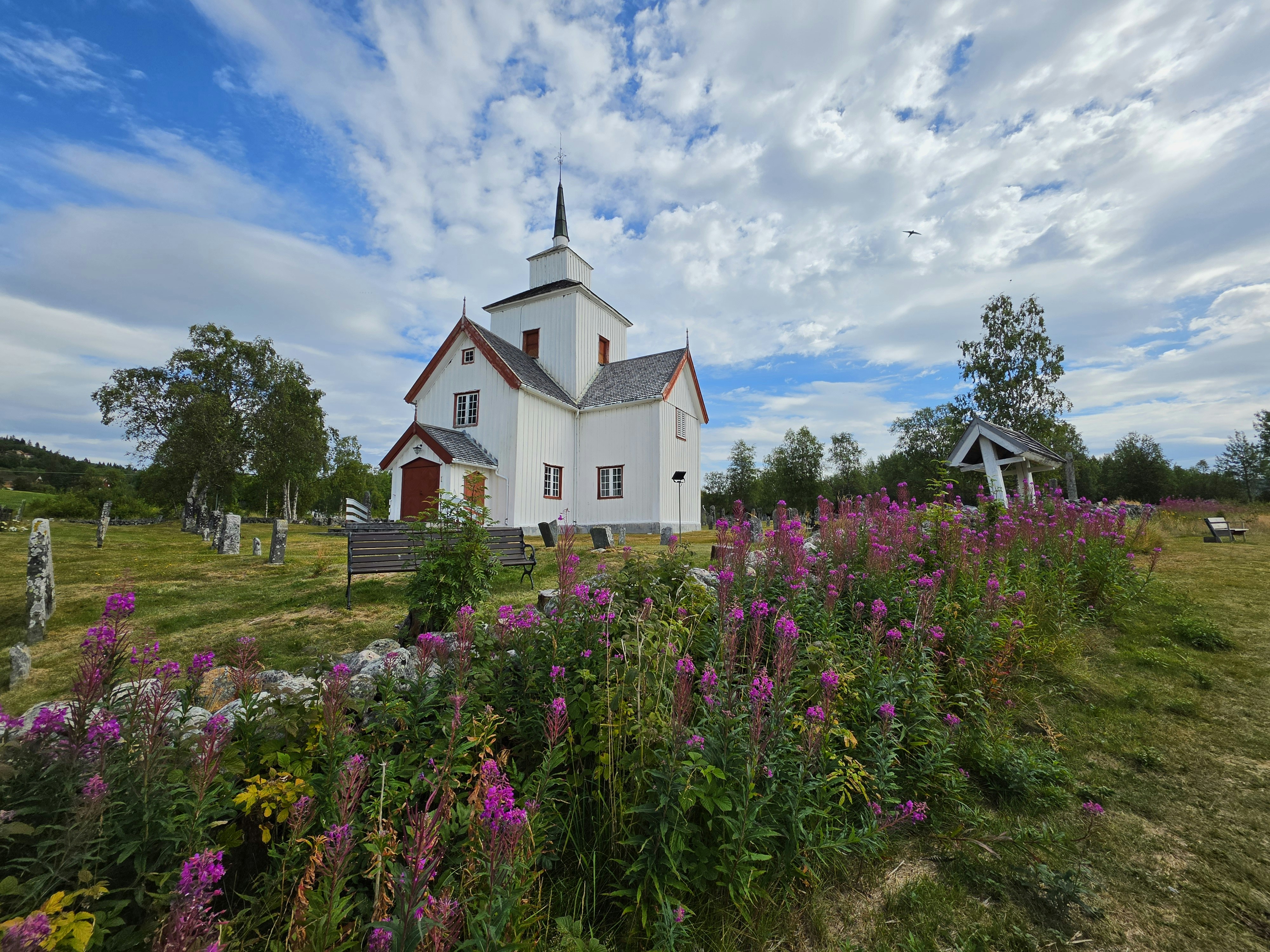 White Chapel Amid Lavender Blooms Under Expansive Sky