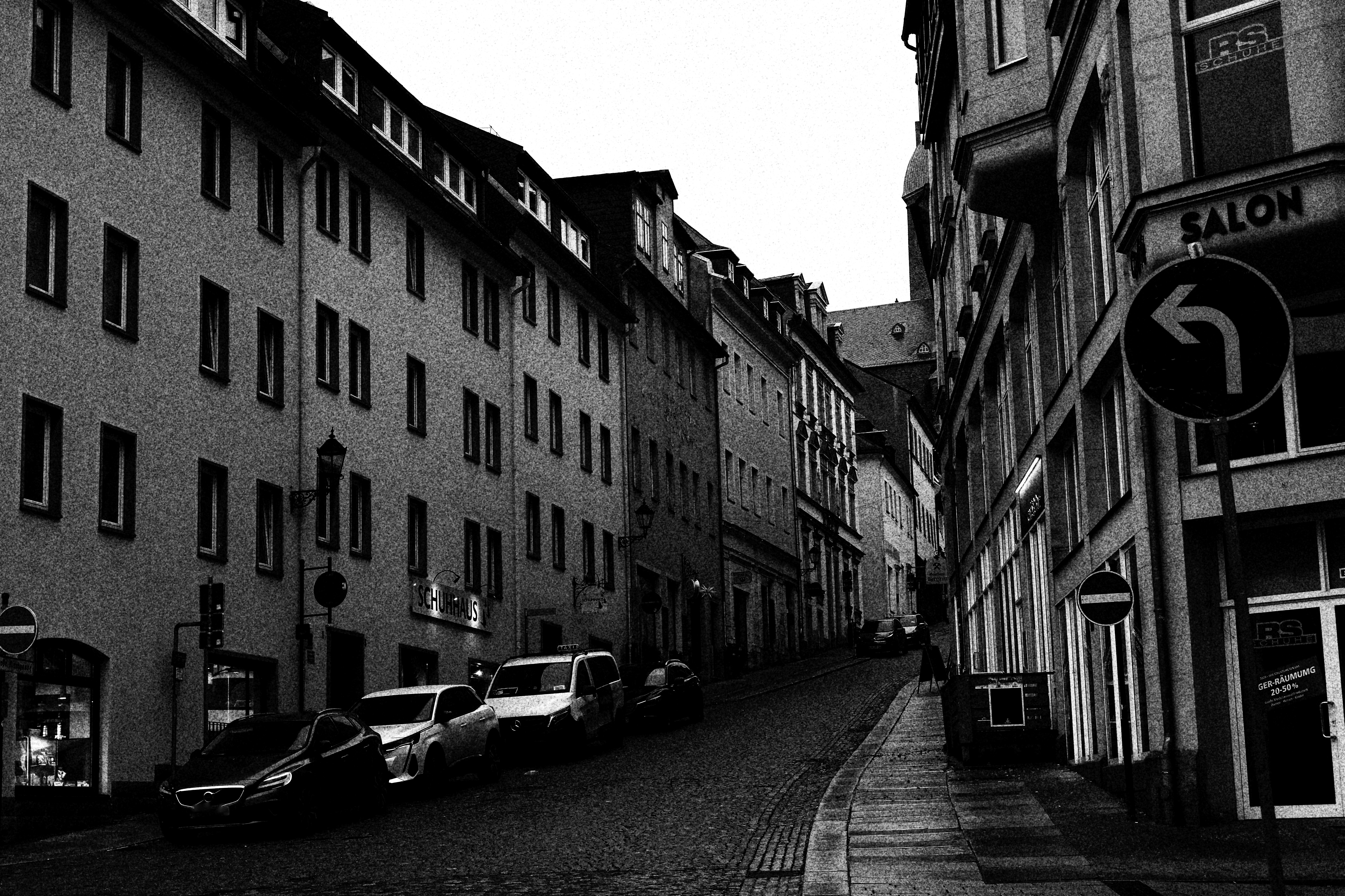 Cobblestone incline: a quiet street in monochrome