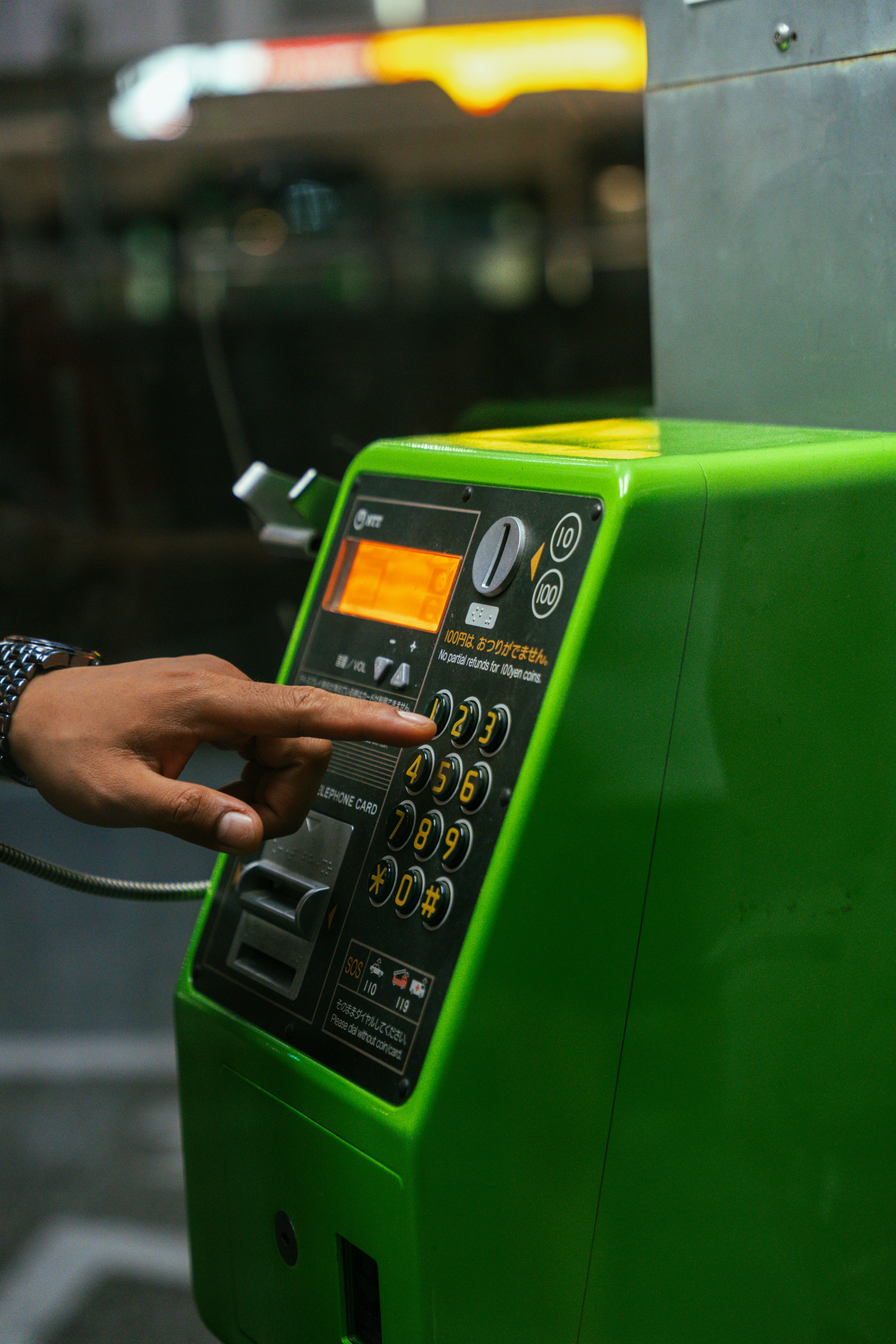 Green Pay Terminal: A Hand Reaches to Tap a Card