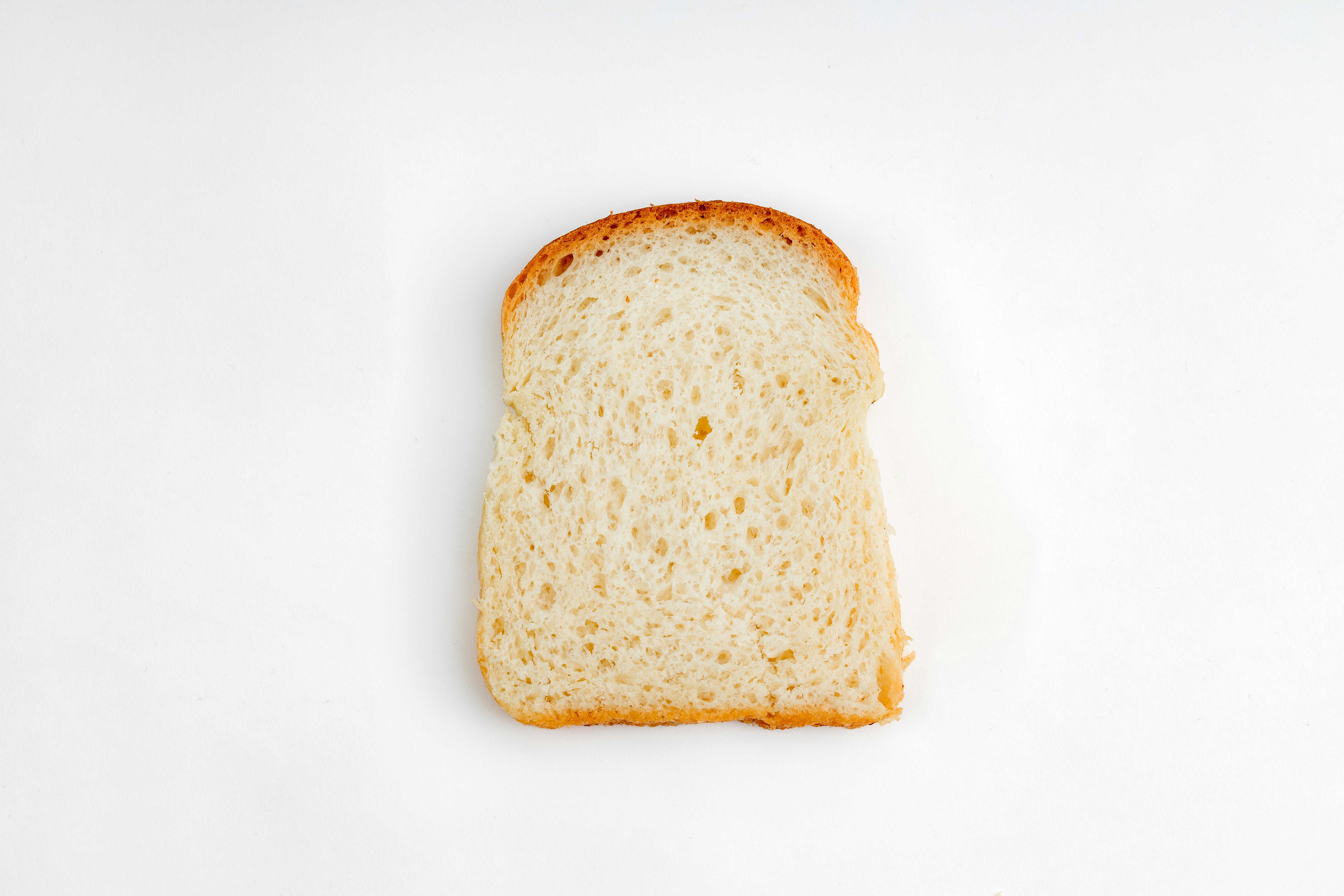 Slice of Quiet: A lone toast on white