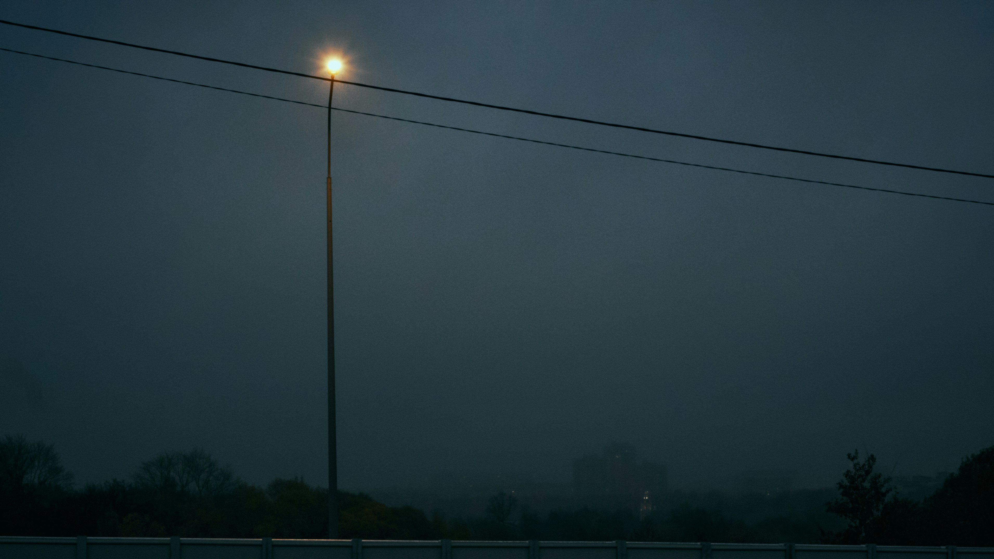 Night Streetlight Beyond a Quiet Horizon