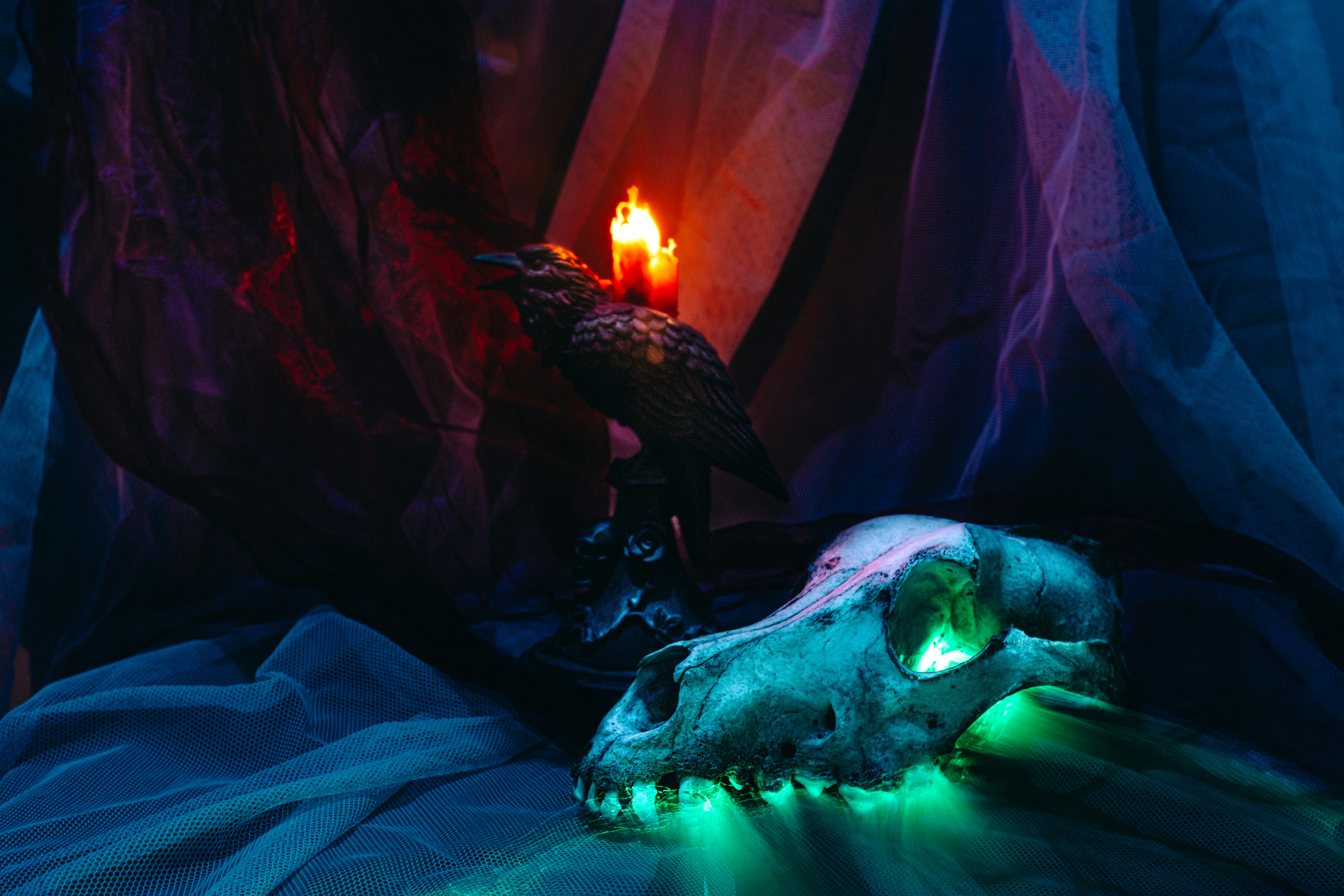 Candlelit Ritual: A Glowing Skull Beneath Shrouded Drapery