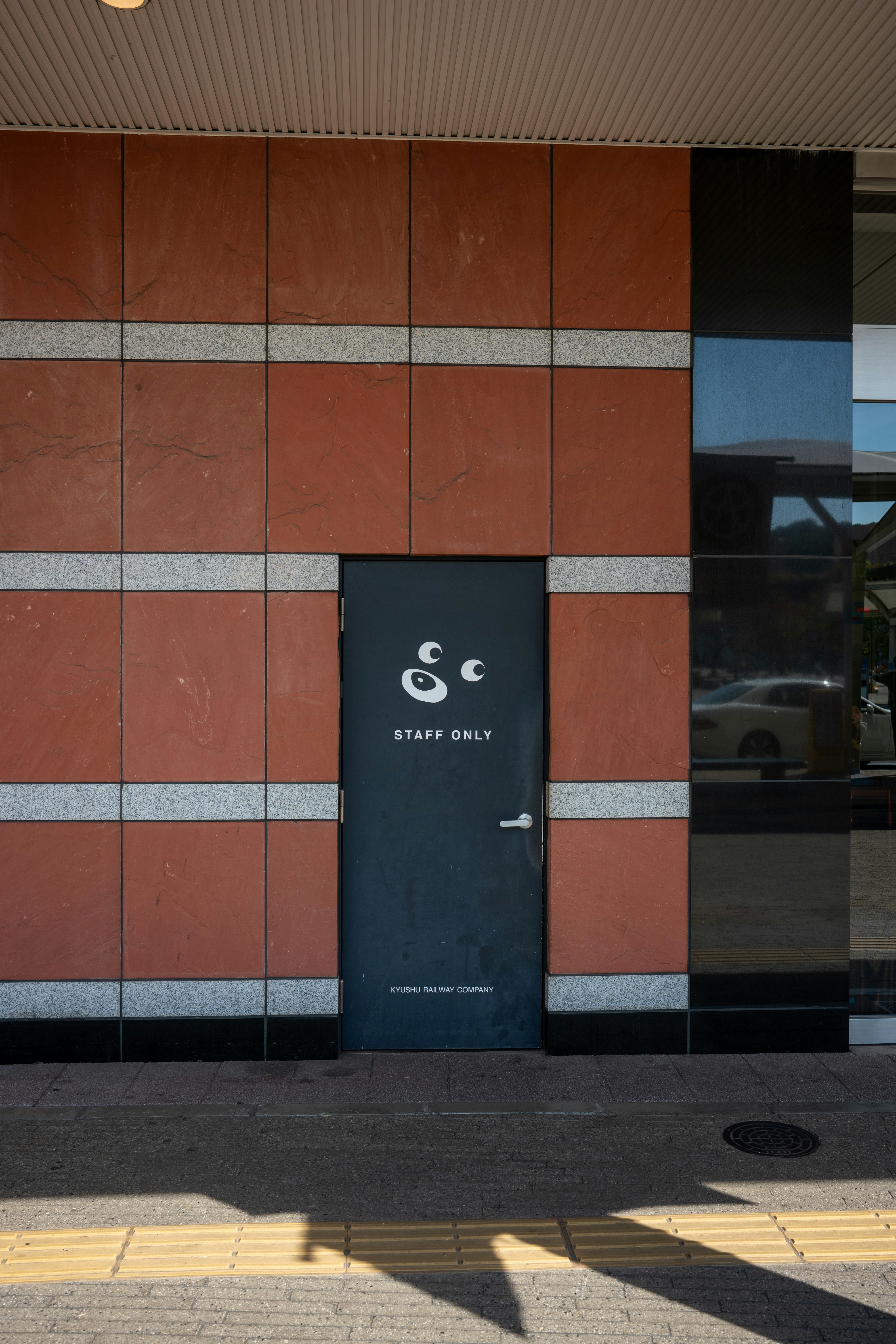 Staff Only: A Quiet Door in Red Brick Facade