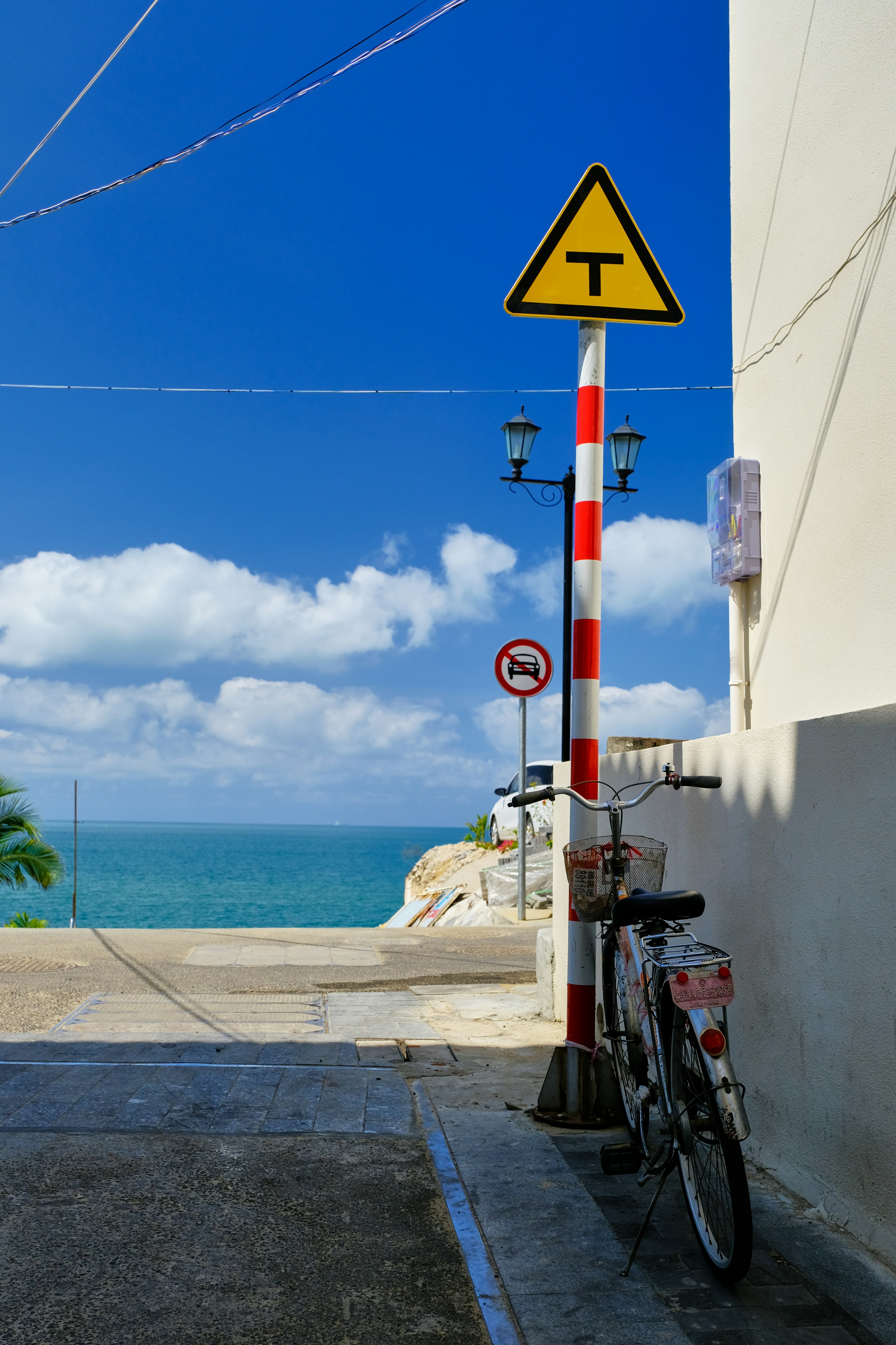 Coastal Threshold: A Tipped Sign, Bicycle, and Ocean Horizon