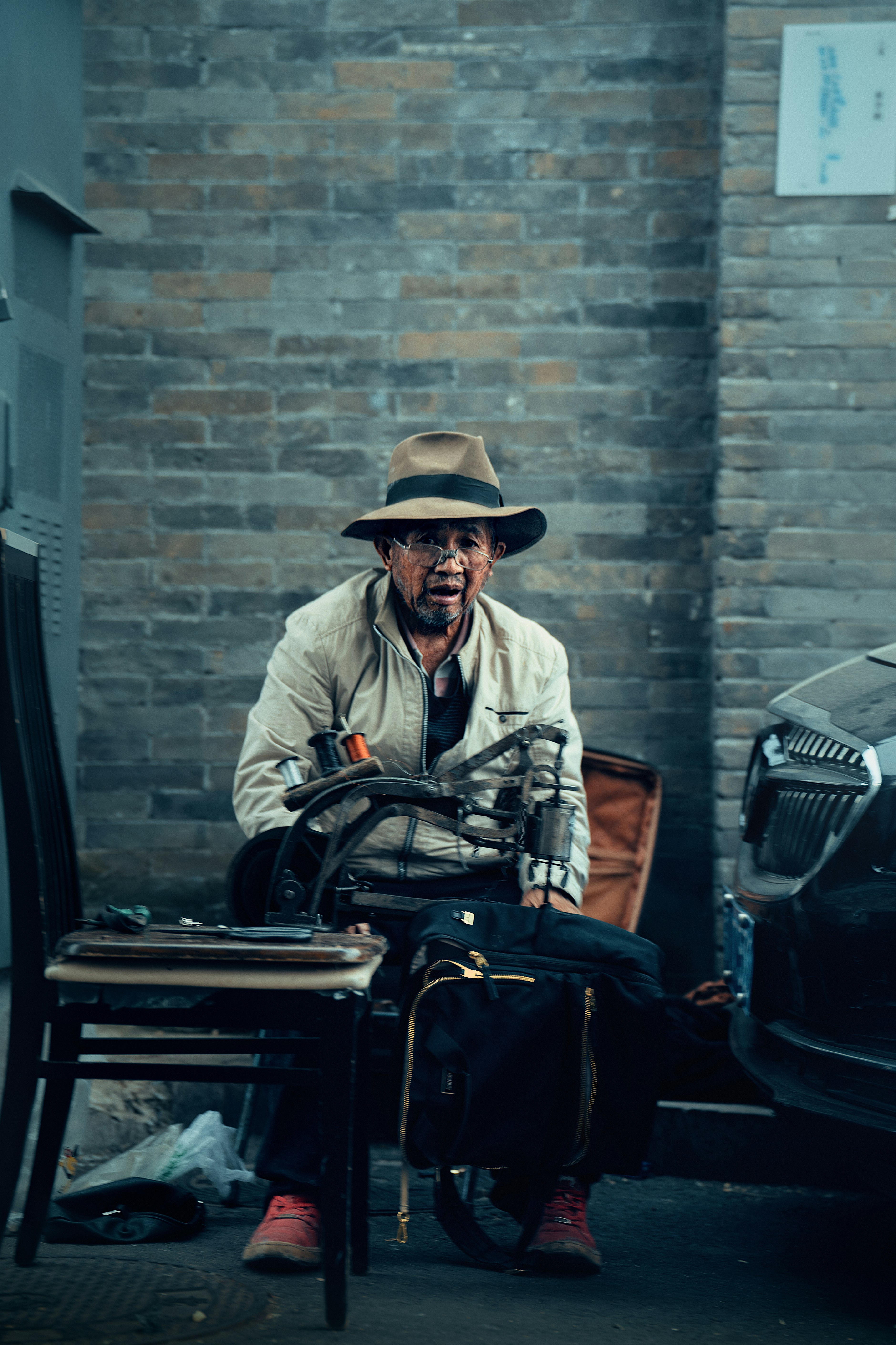 Street Corner Luthier: A Weathered Traveler with Gear and Hat