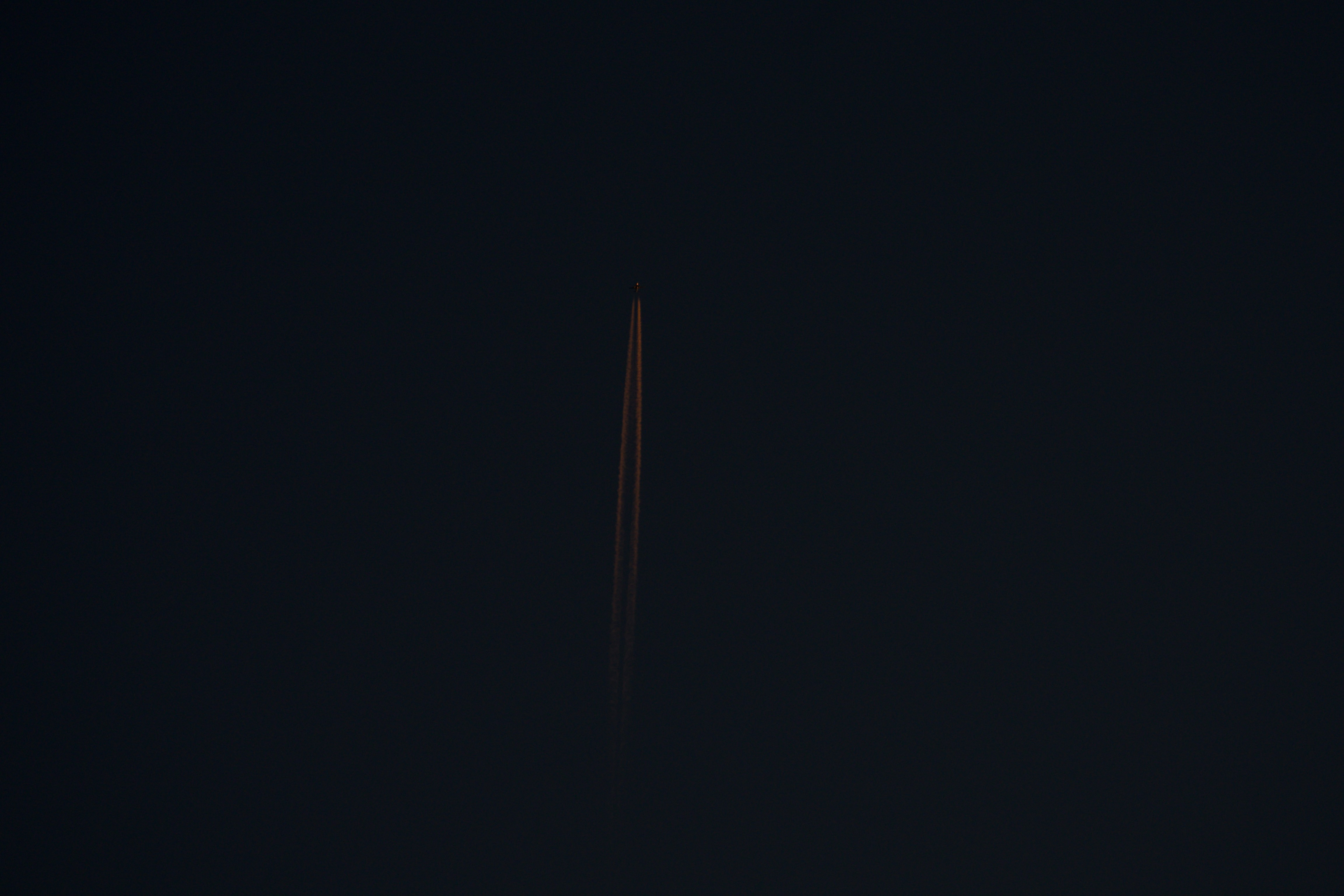 Vertical Ember: A Narrow Trail of Light in the Night