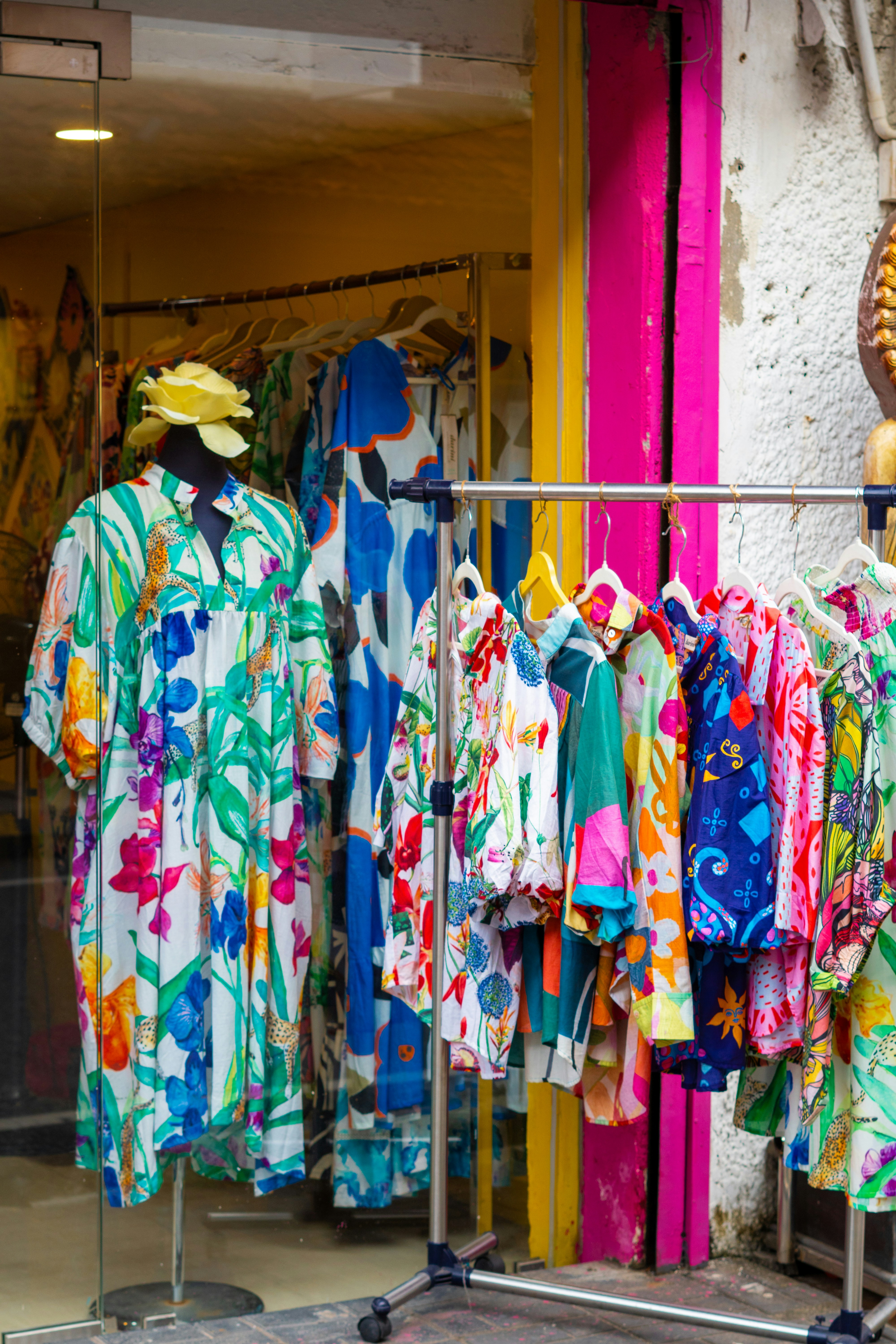 Vibrant Boutique Display: Colorful Garments on a Street Rack