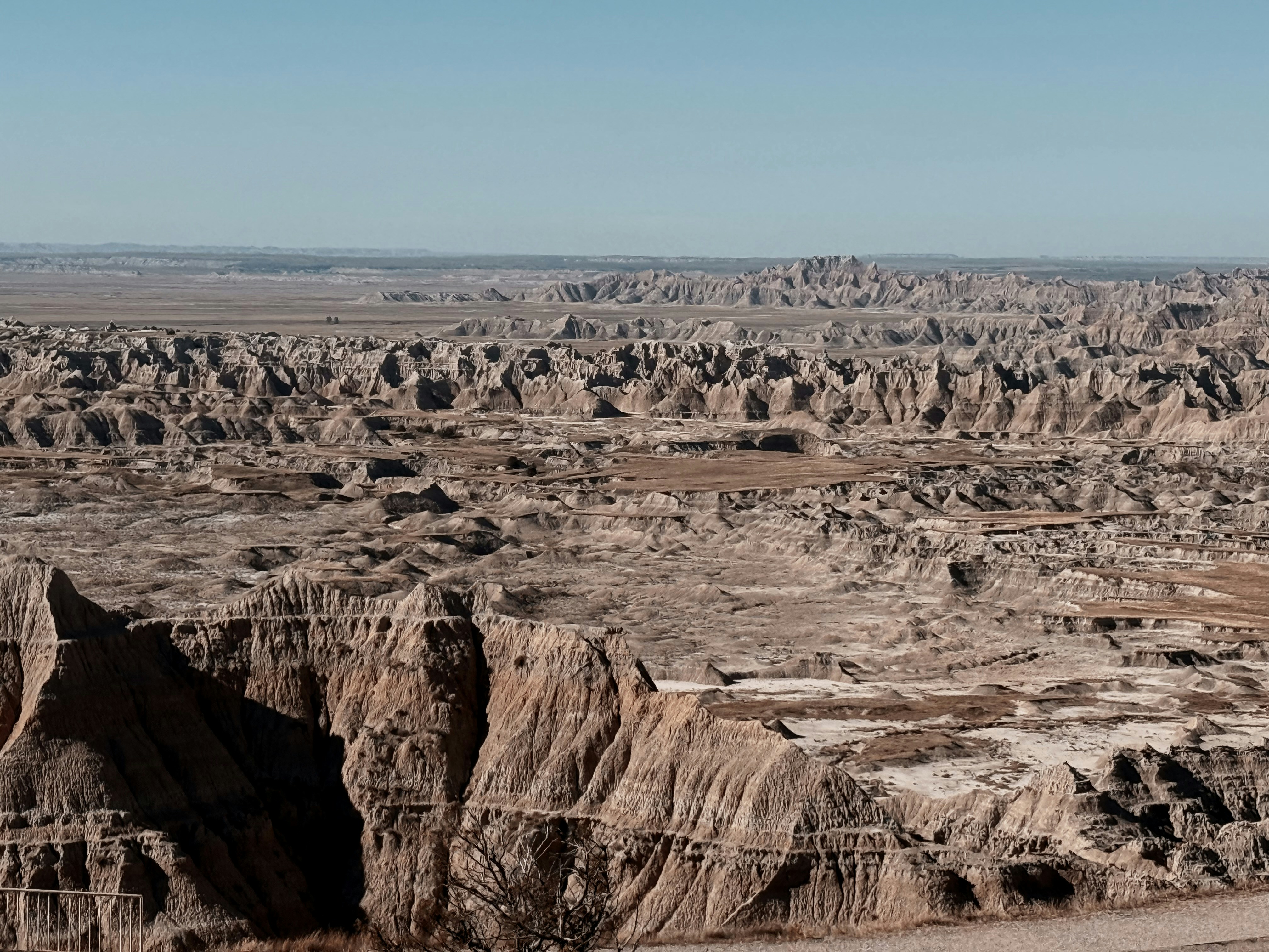 Desert Labyrinth: A Sea of Clay and Erosion Under a Clear Blue Sky