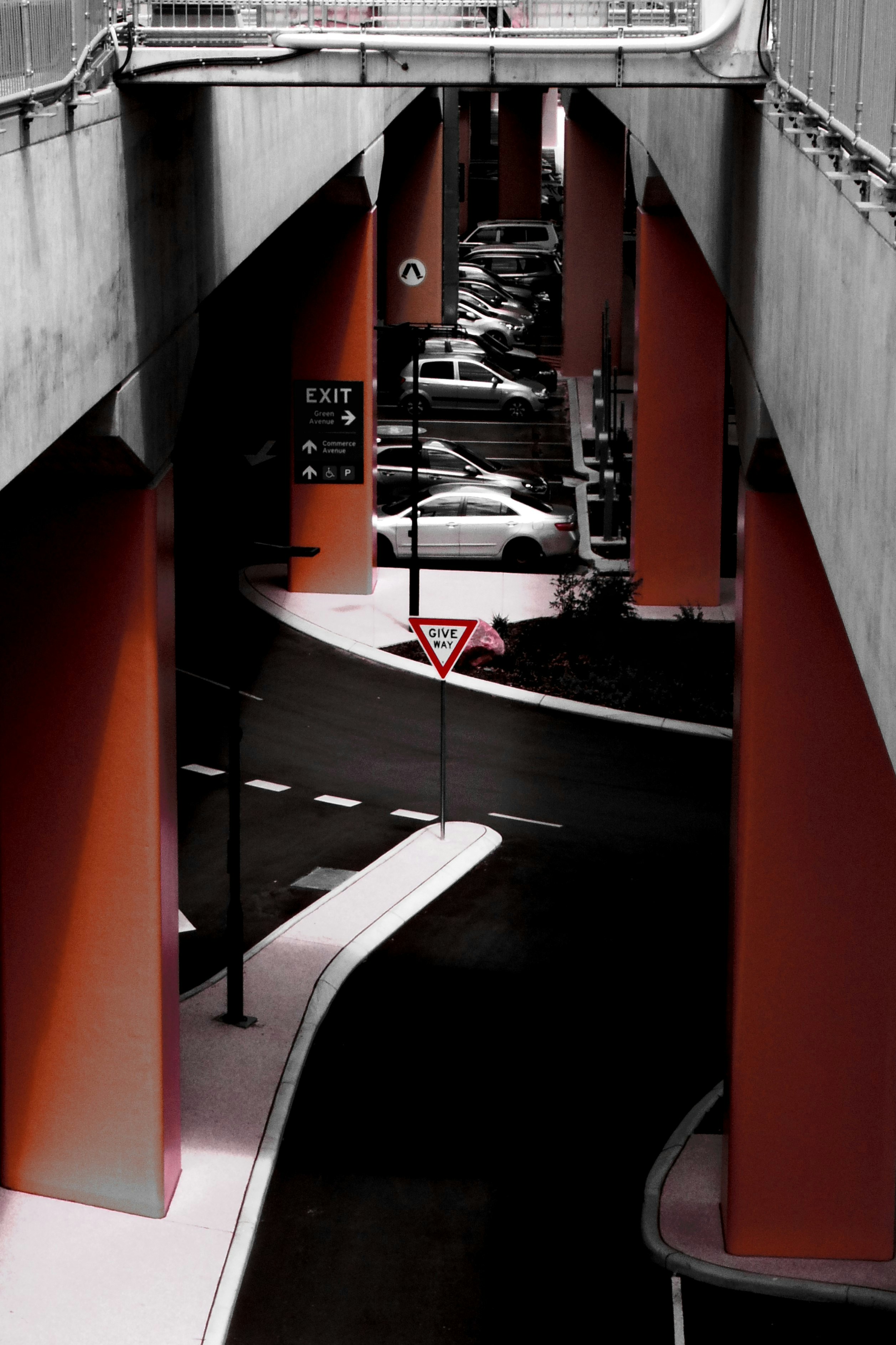Concrete canyon: orange pillars frame a curving roadway crossroads