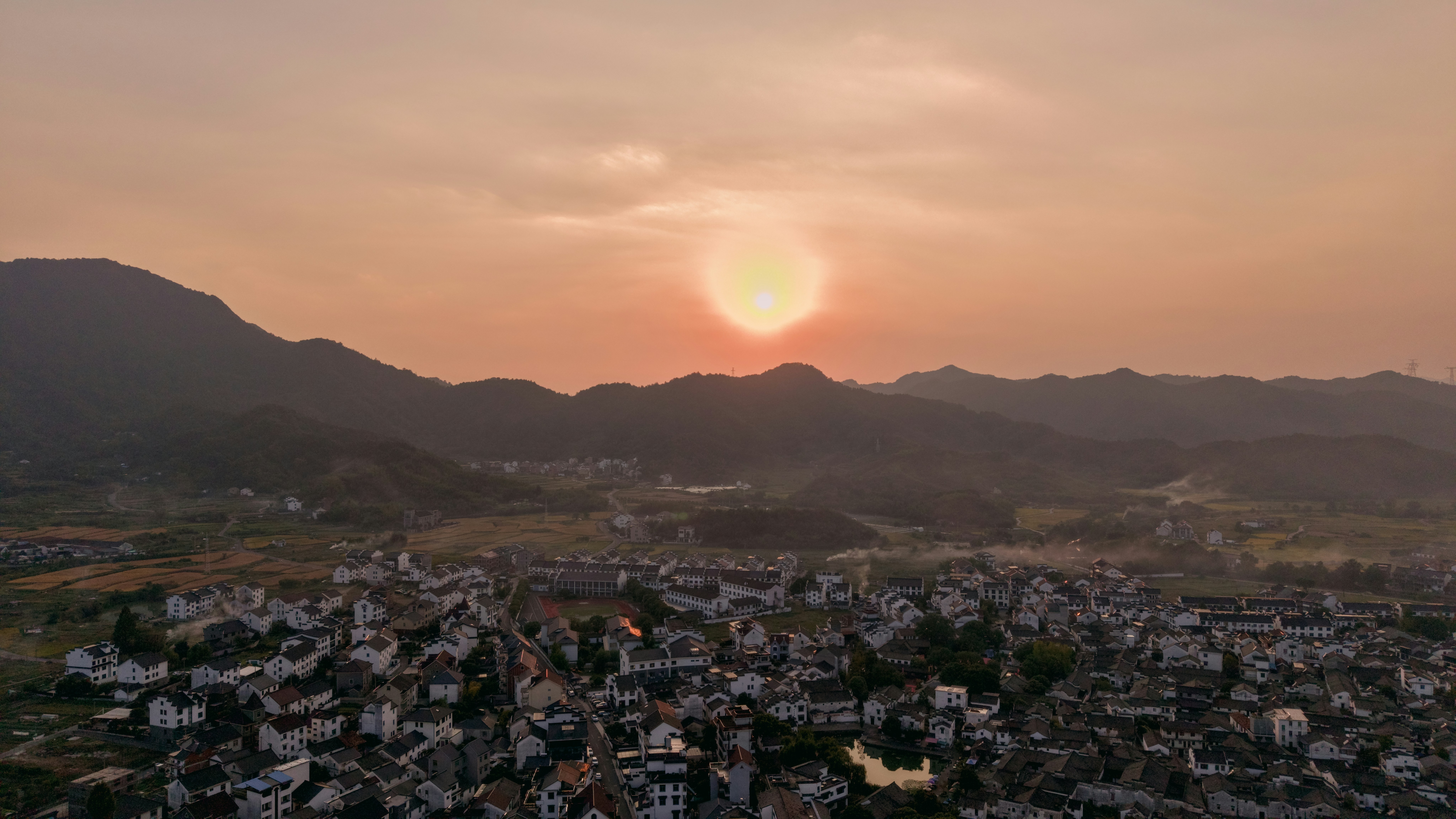 Sunset Over the Quiet Valley: Distant Ridge and Town