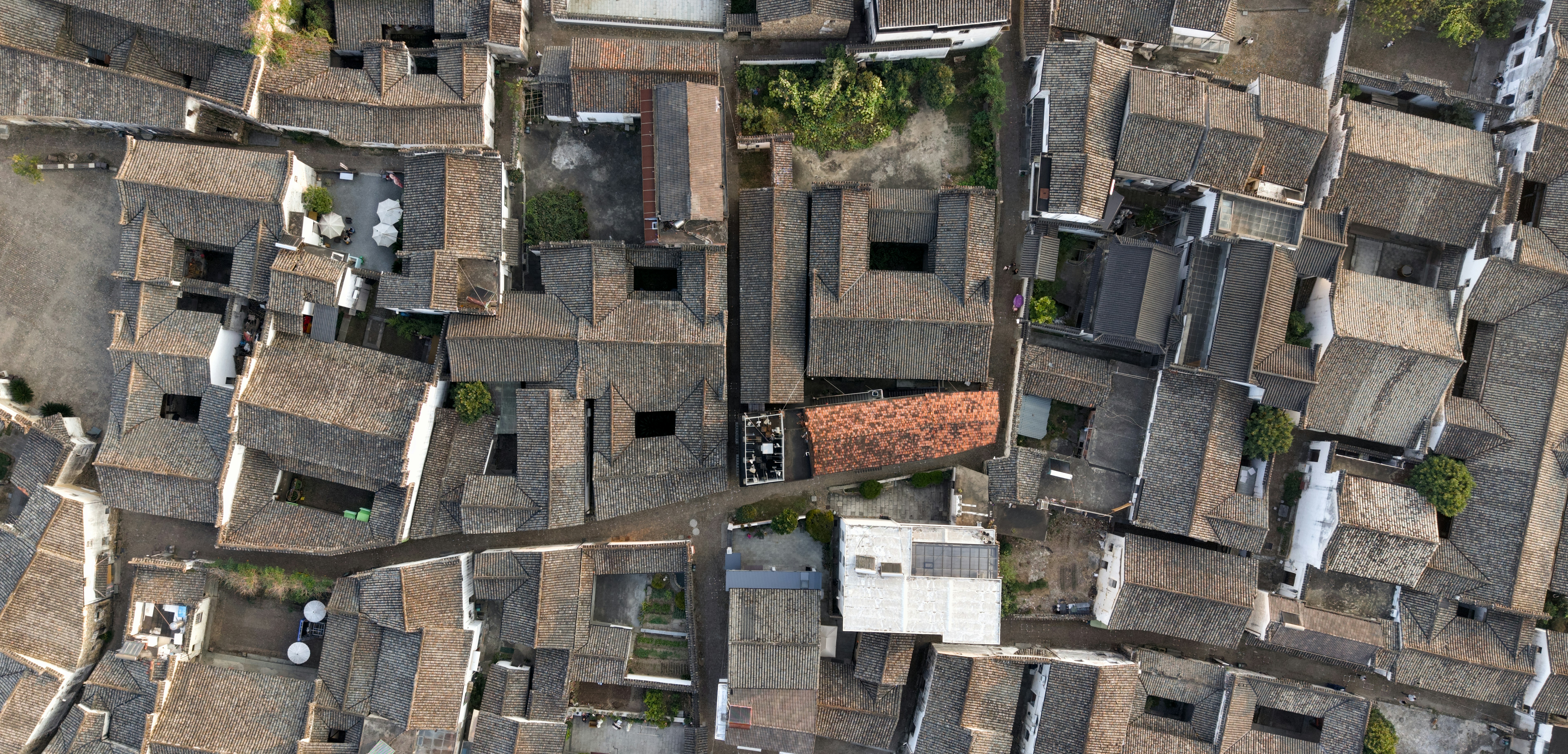 Tiled Urban Maze: Aerial Snapshot of Narrow Courtyards and Rooftops