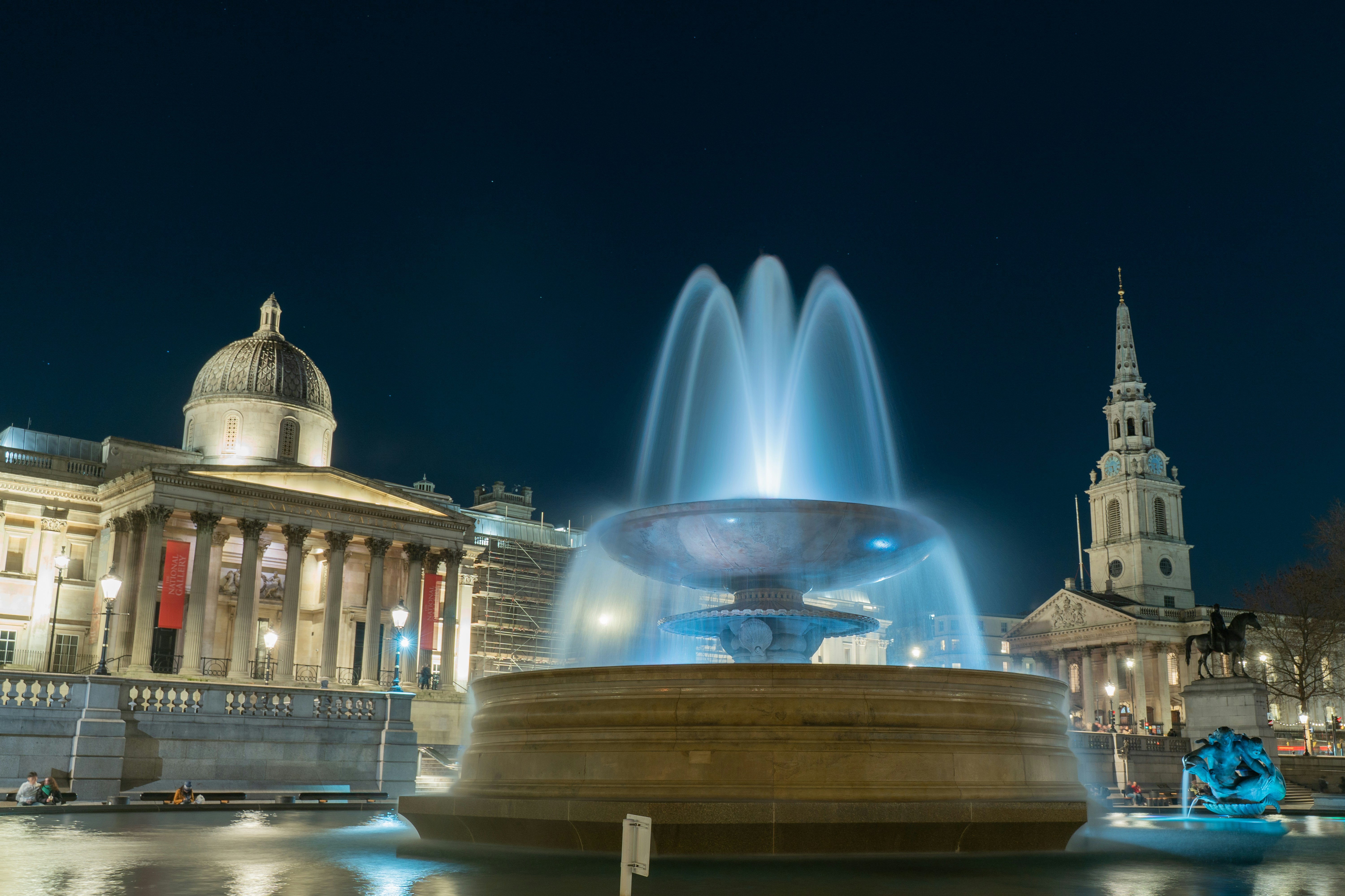 Night Pulse: The Illuminated Fountain Amid Classic City Silhouettes