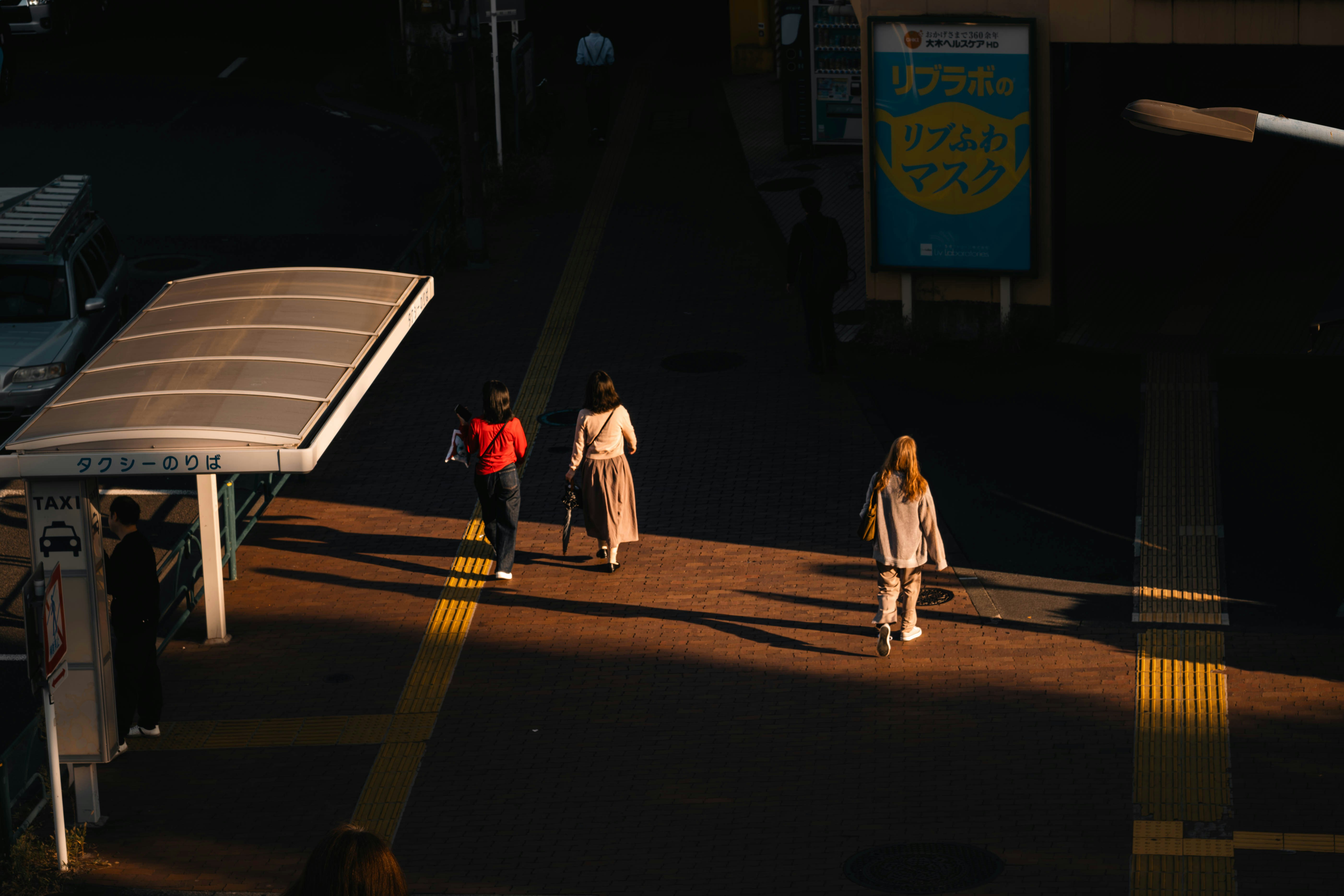 Golden Hour Crossing: Quiet Stride Under Streetlight Illumination