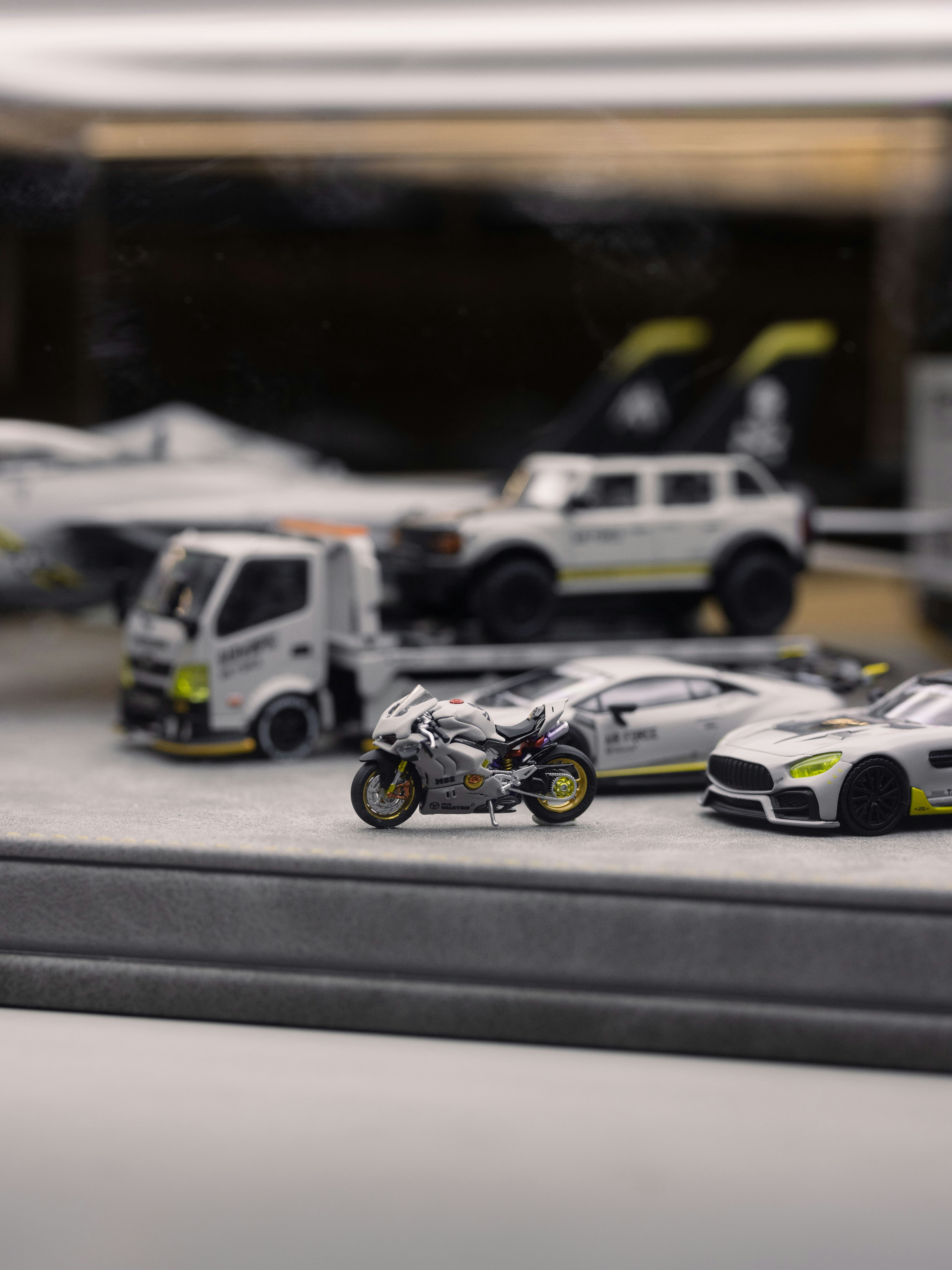 Miniature Motors: A Lineup of Tiny Wheels Guarded by a Tarmac Stage