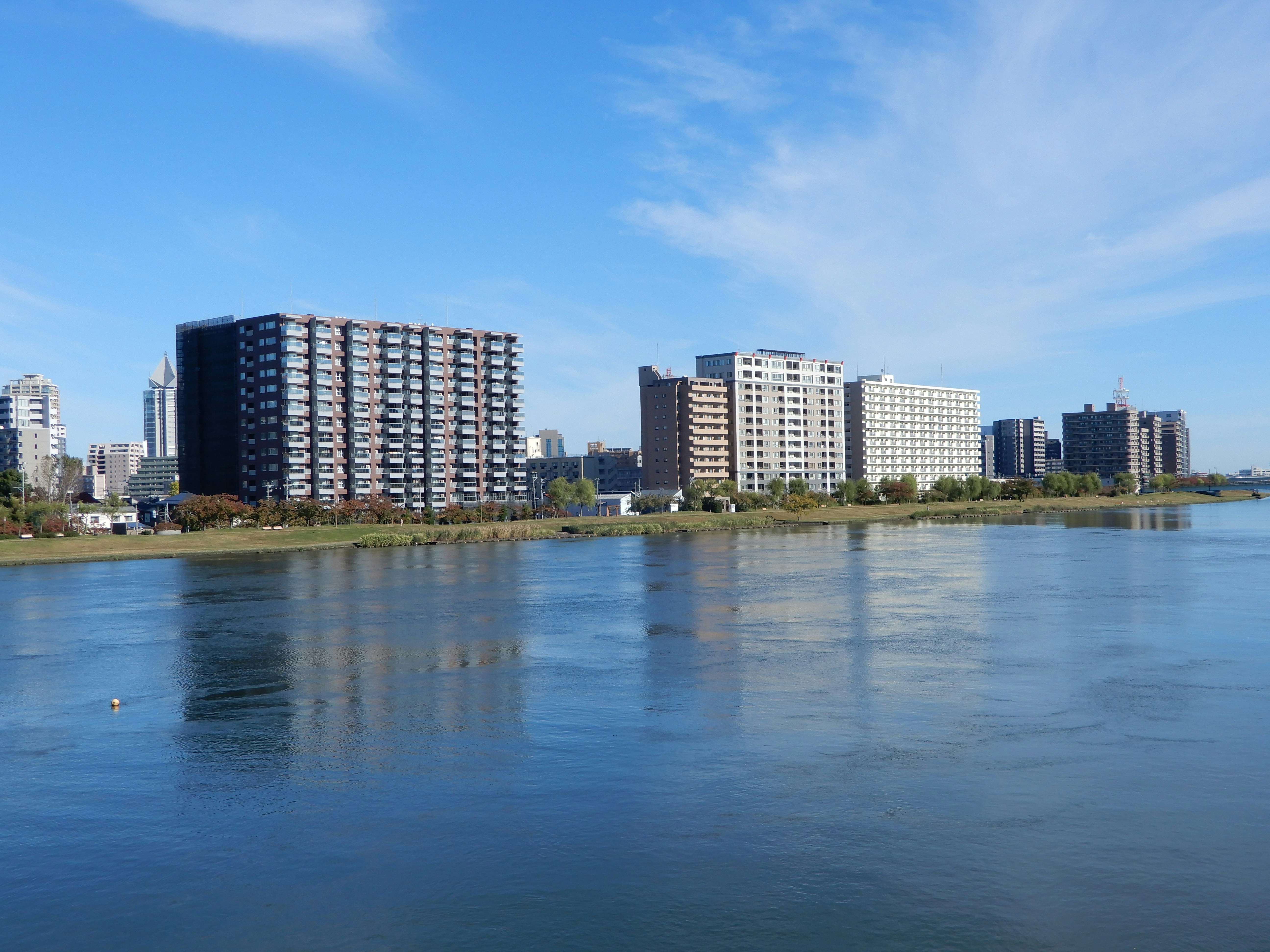 Riverfront skyline under a clear blue sky