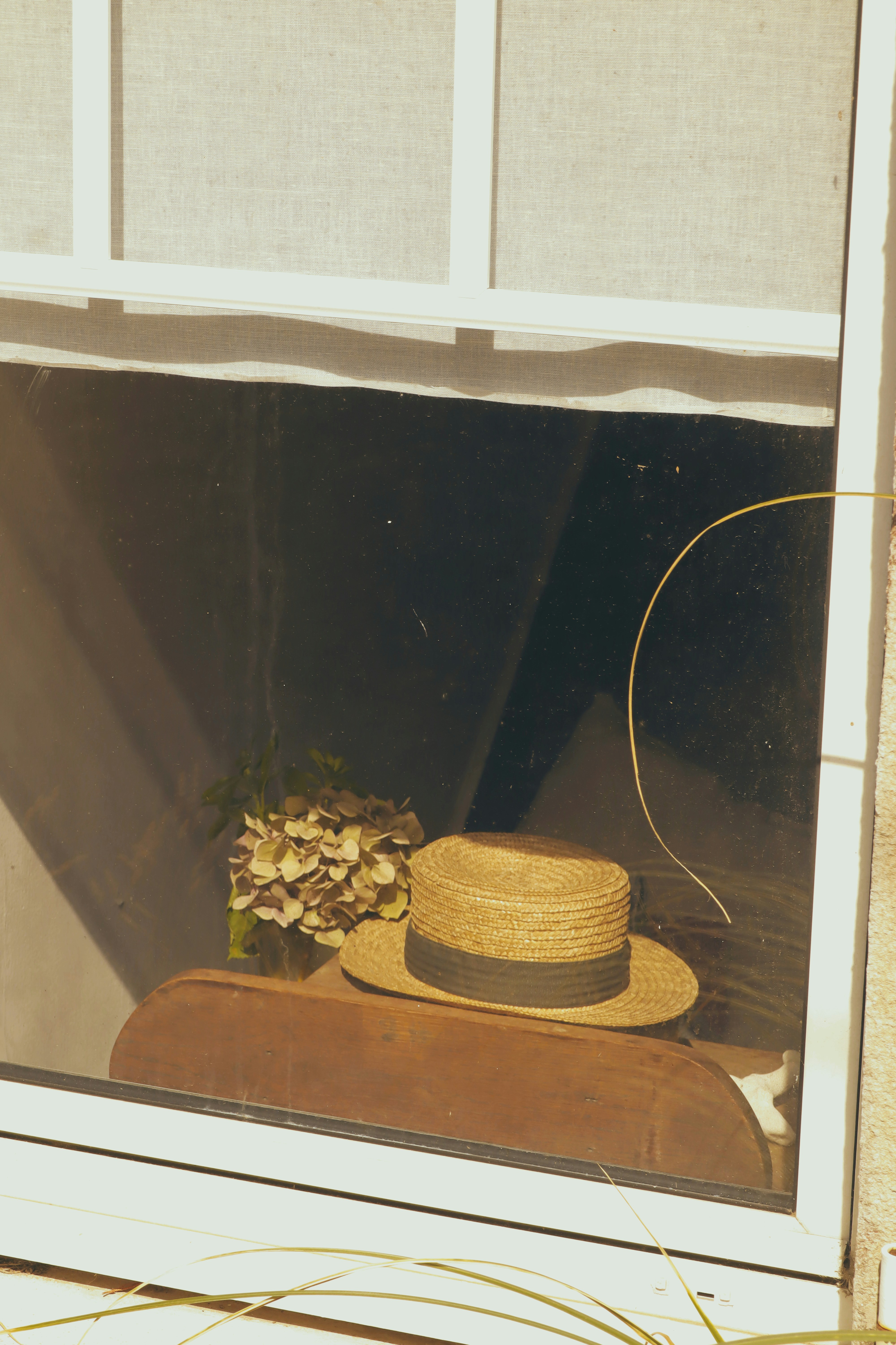 Straw Hat on a Quiet Window Sill