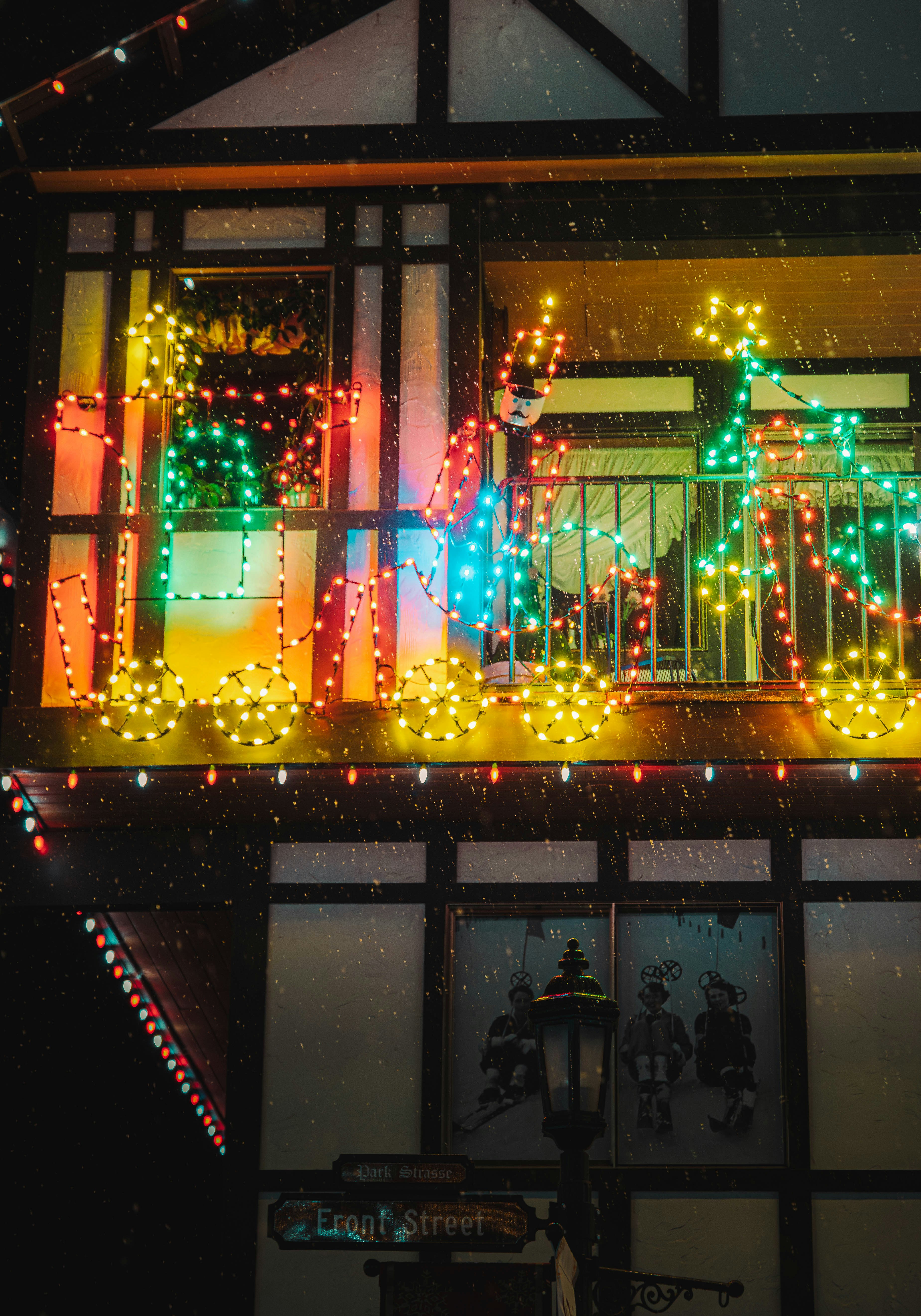 Festive Balcony Glow Over a Tudor-Style Street Scene